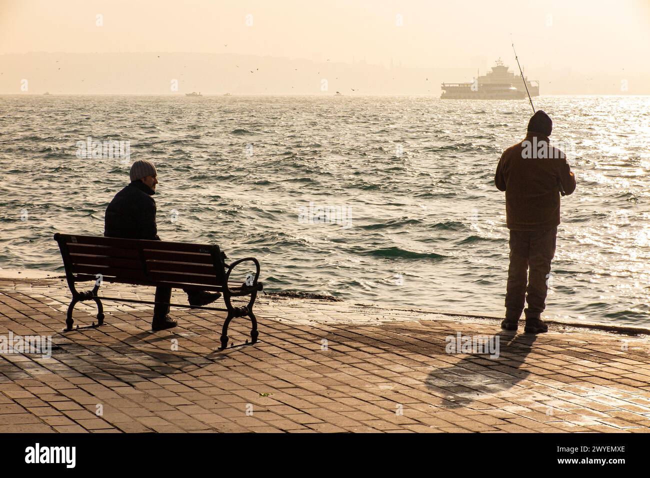 Fisherman fishing in the Bosphorus sea, Turkey as teh sun sets Stock ...