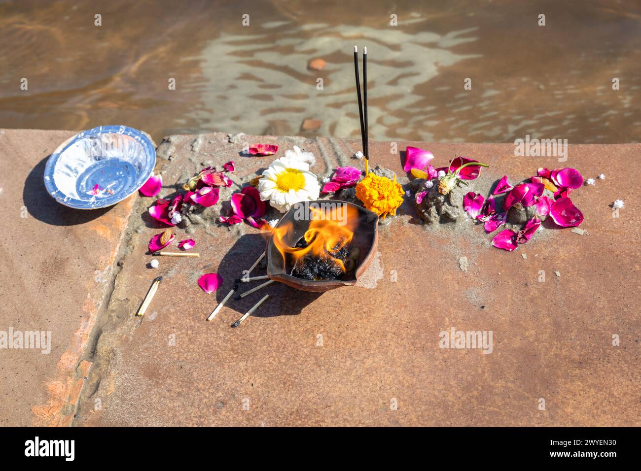 holy offerings by devotee at religious river shore at morning from flat ...