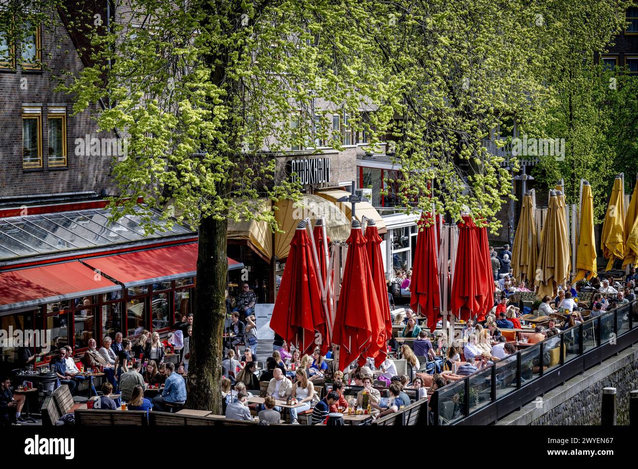 ROTTERDAM - People sit on the terrace in the old harbor during the nice ...