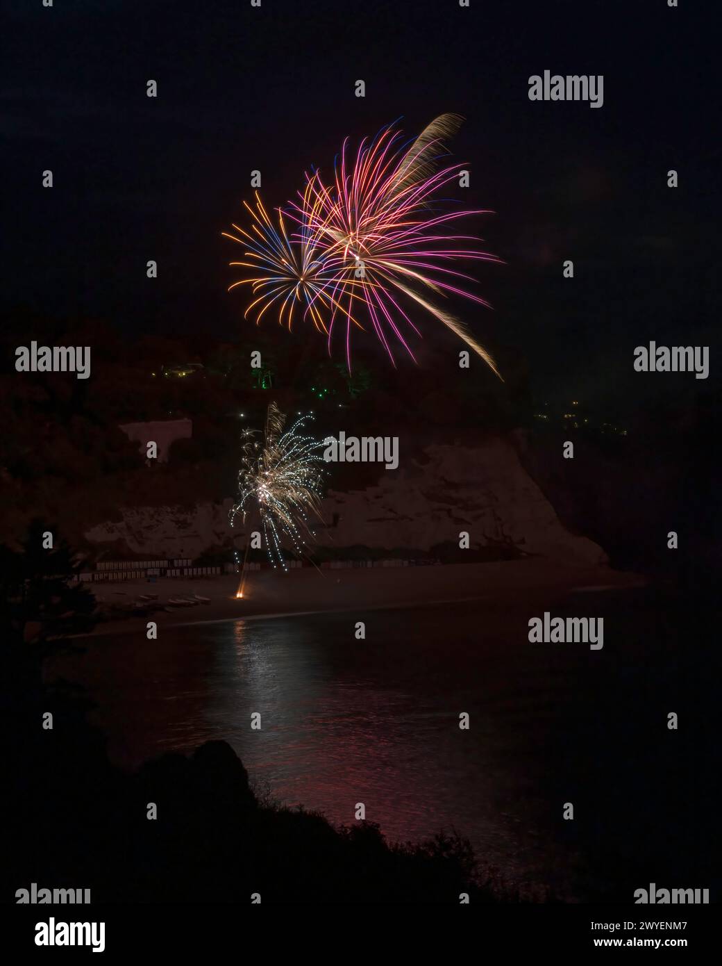 A firework display on the beach at Beer, Devon, England, UK, part of ...