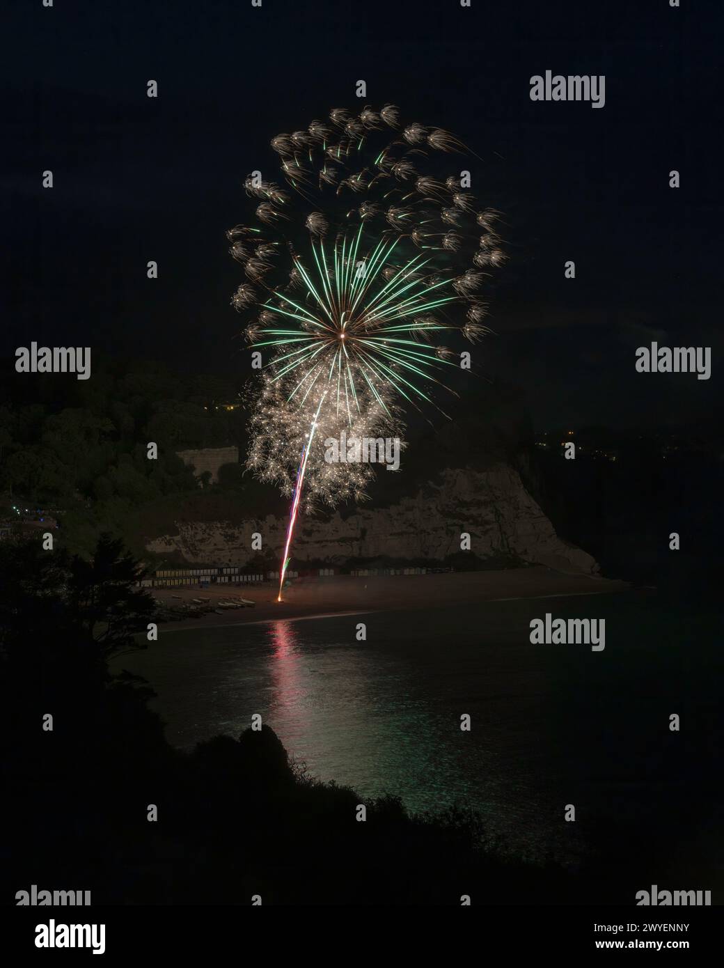 A firework display on the beach at Beer, Devon, England, UK, part of ...