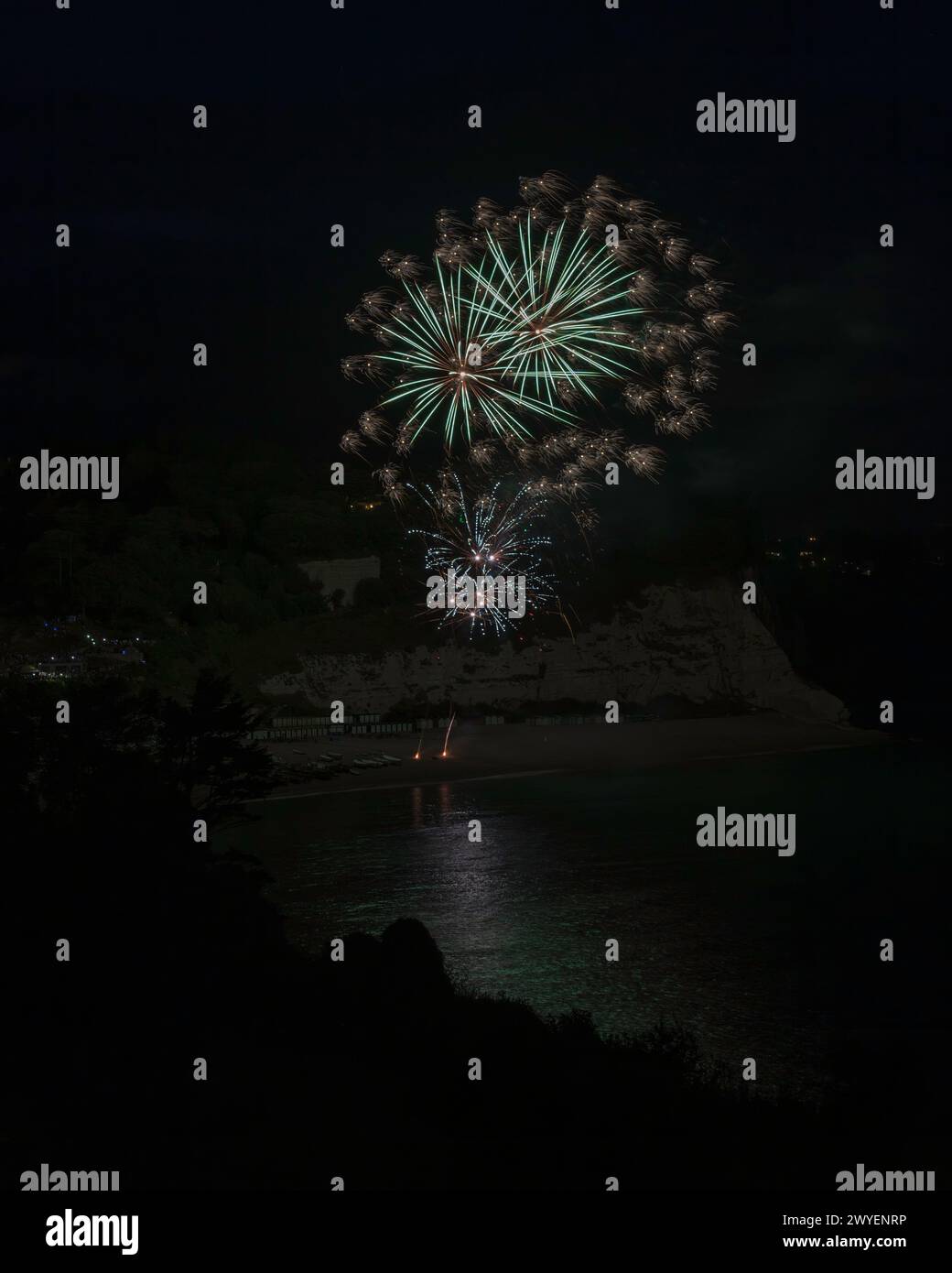A firework display on the beach at Beer, Devon, England, UK, part of ...