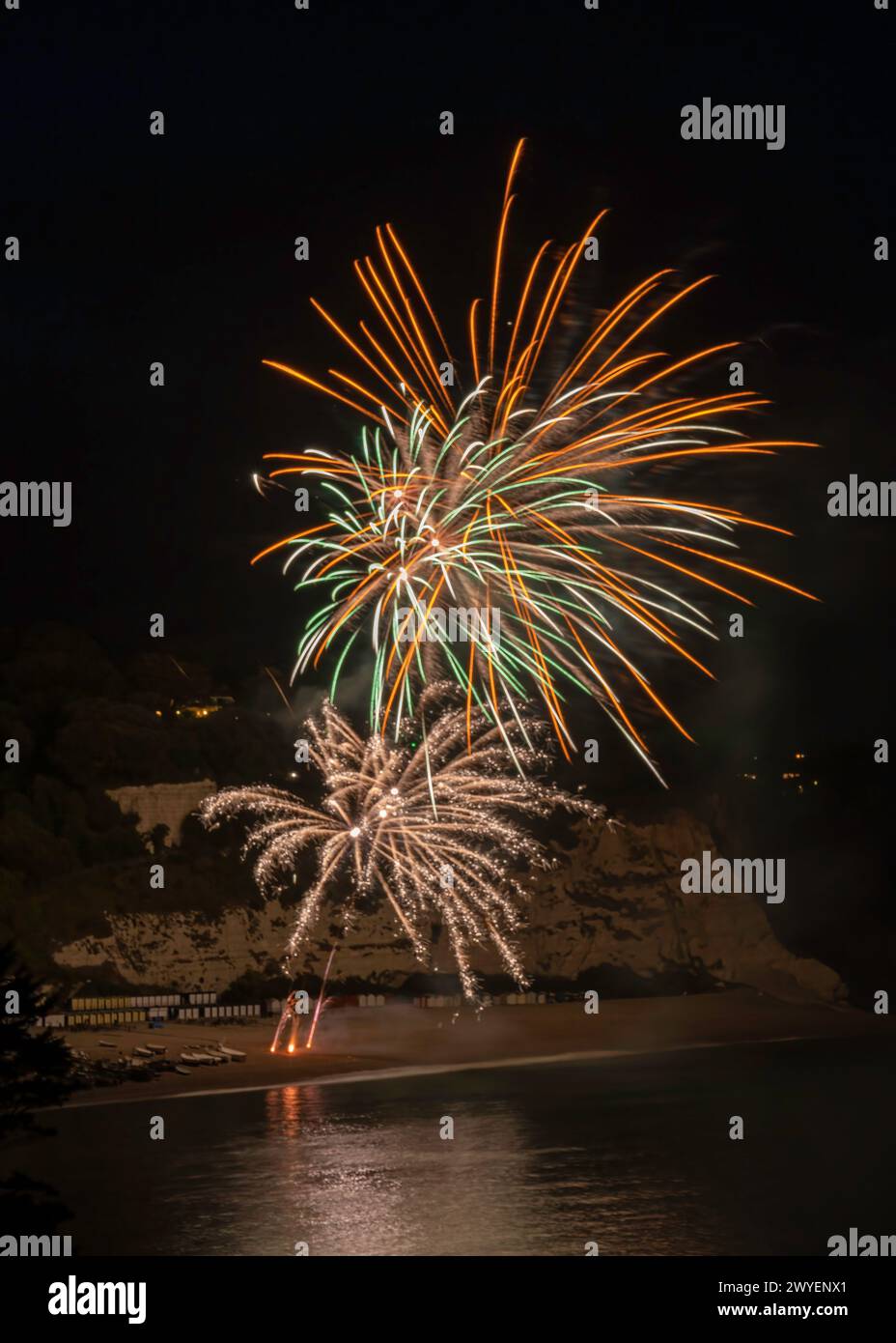 A firework display on the beach at Beer, Devon, England, UK, part of ...