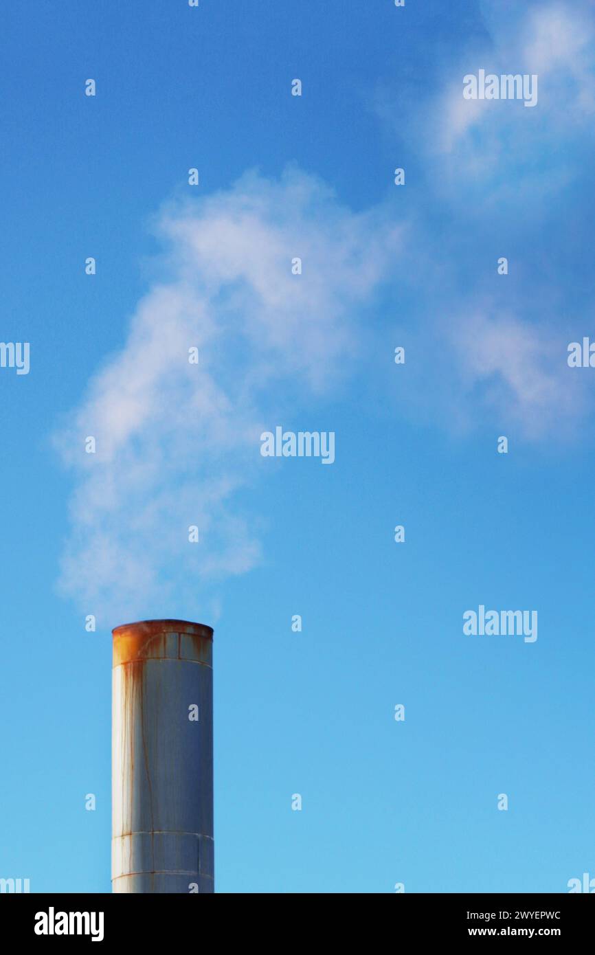 Rusty chimney. A metal pipe with white smoke coming from it ...