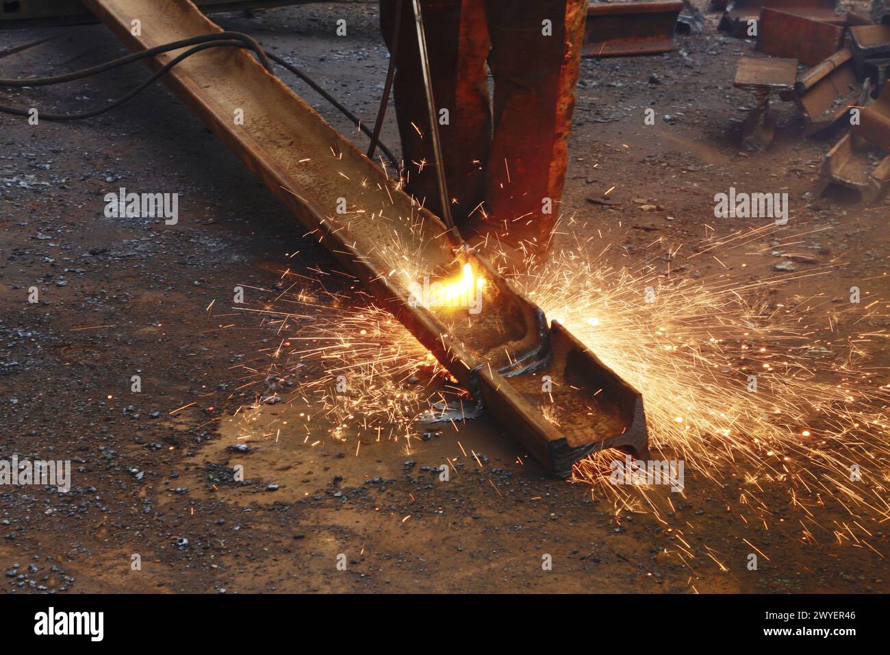 Cutting an old metal rail with a gas burner flame, close-up. Autogen ...