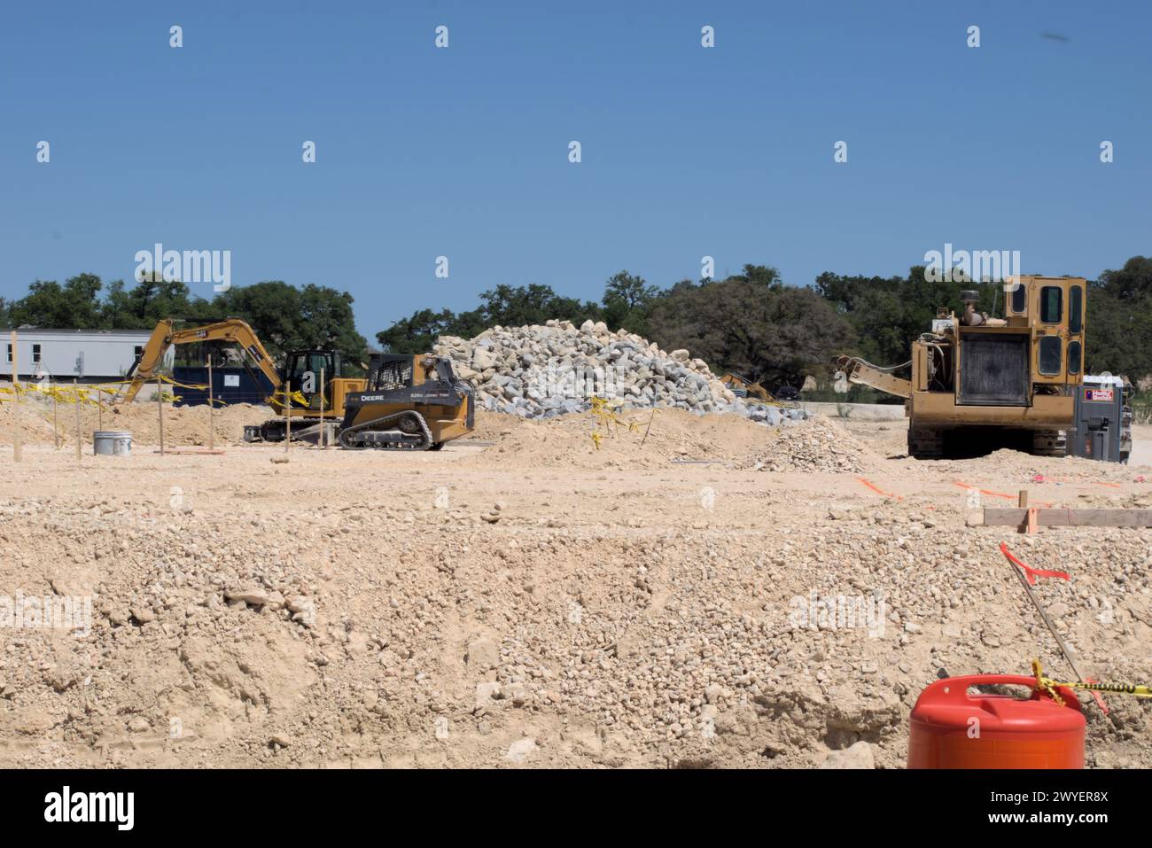 Excavation equipment leveling hills in Texas Hill Country to support ...