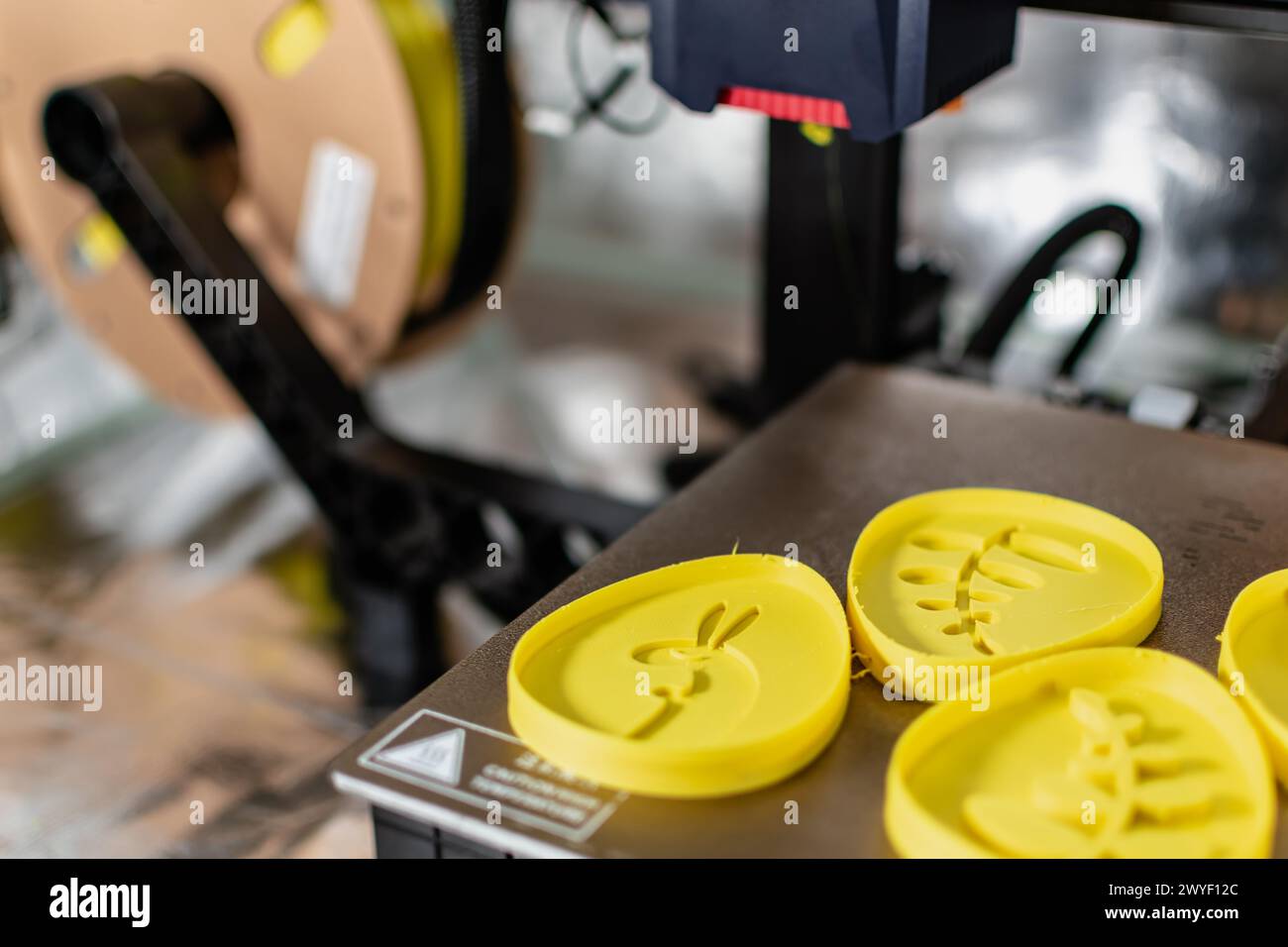 3d printer with some objects on the tray printed with pla filament ...