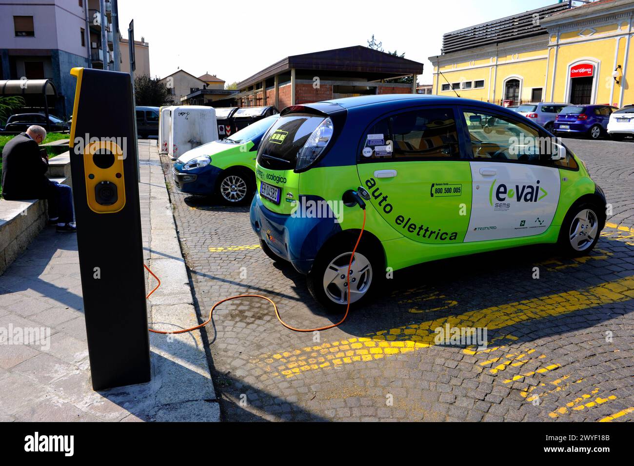 Electric energy green car vehicle charge battery plugged at charging ... Electric energy green car vehicle charge battery plugged at charging ...