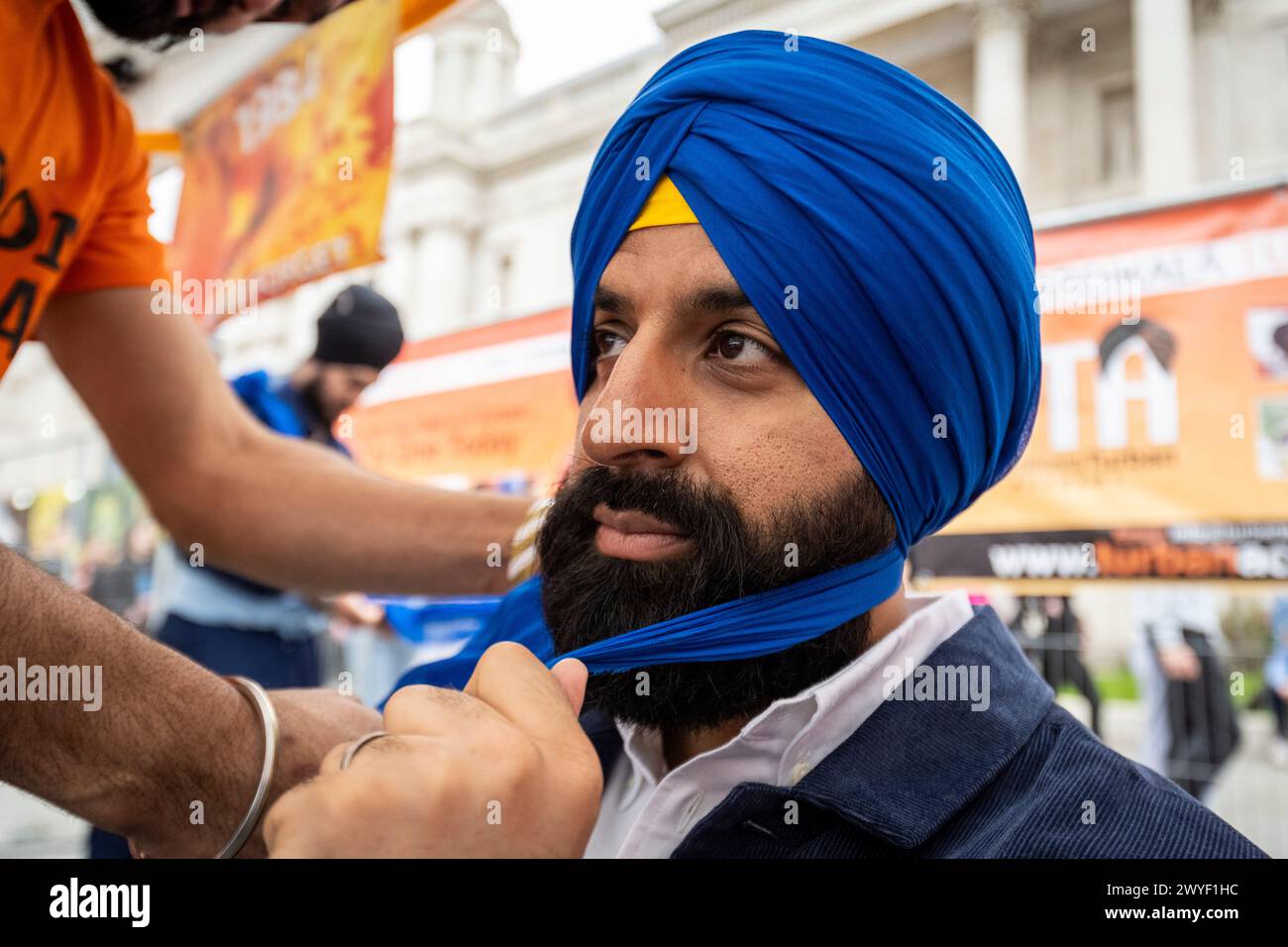 London, UK. 6 April 2024. A visitor has a traditional turban tied by a ...