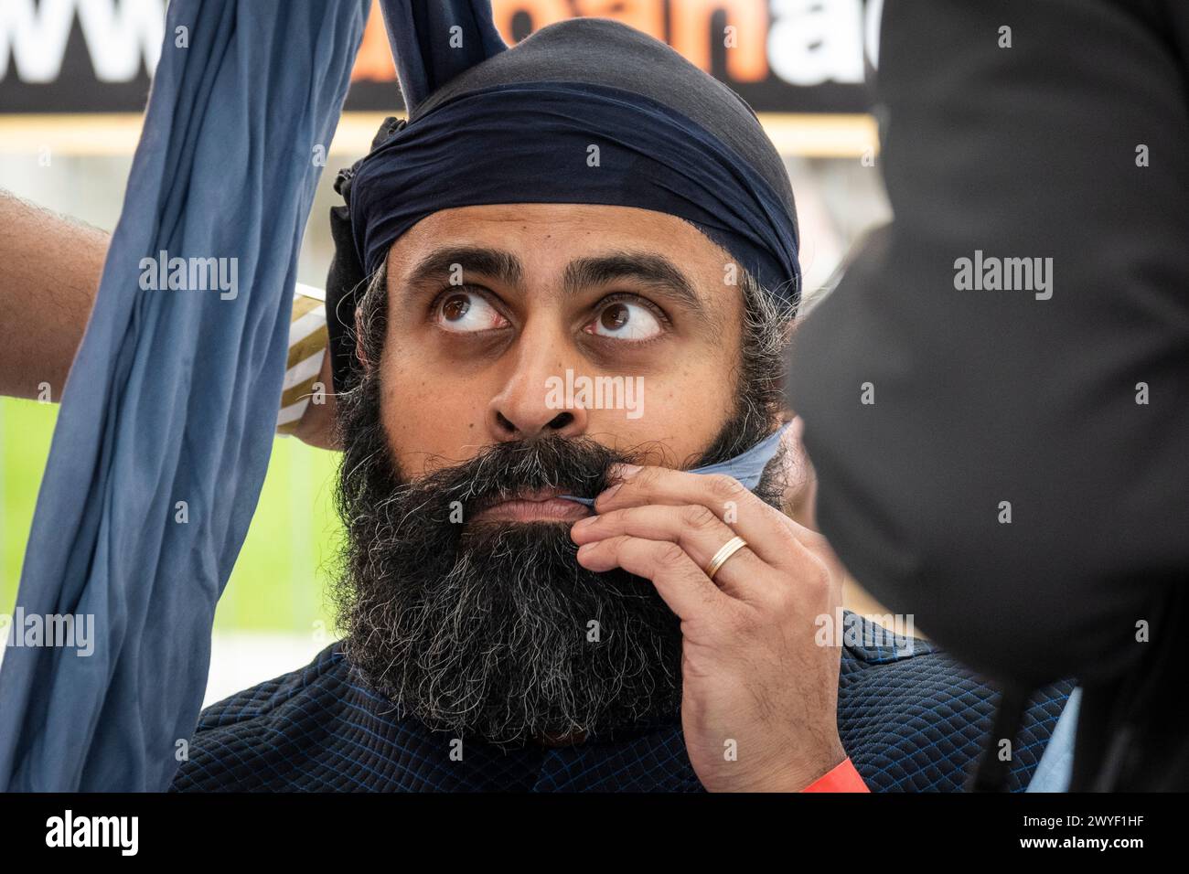 London, UK. 6 April 2024. A visitor has a traditional turban tied by a ...