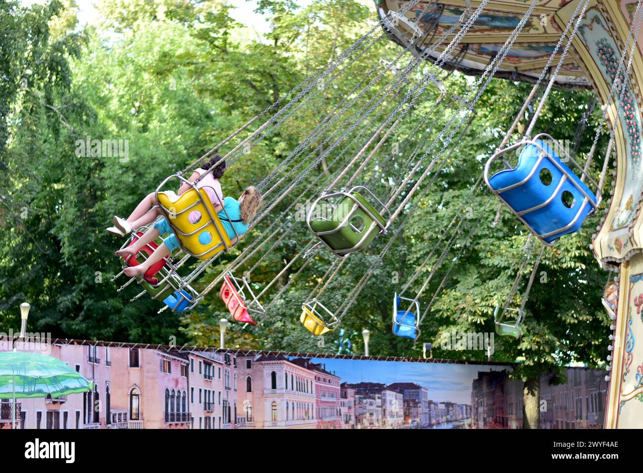 Rotating carousel and carrycots on chains Stock Photo - Alamy