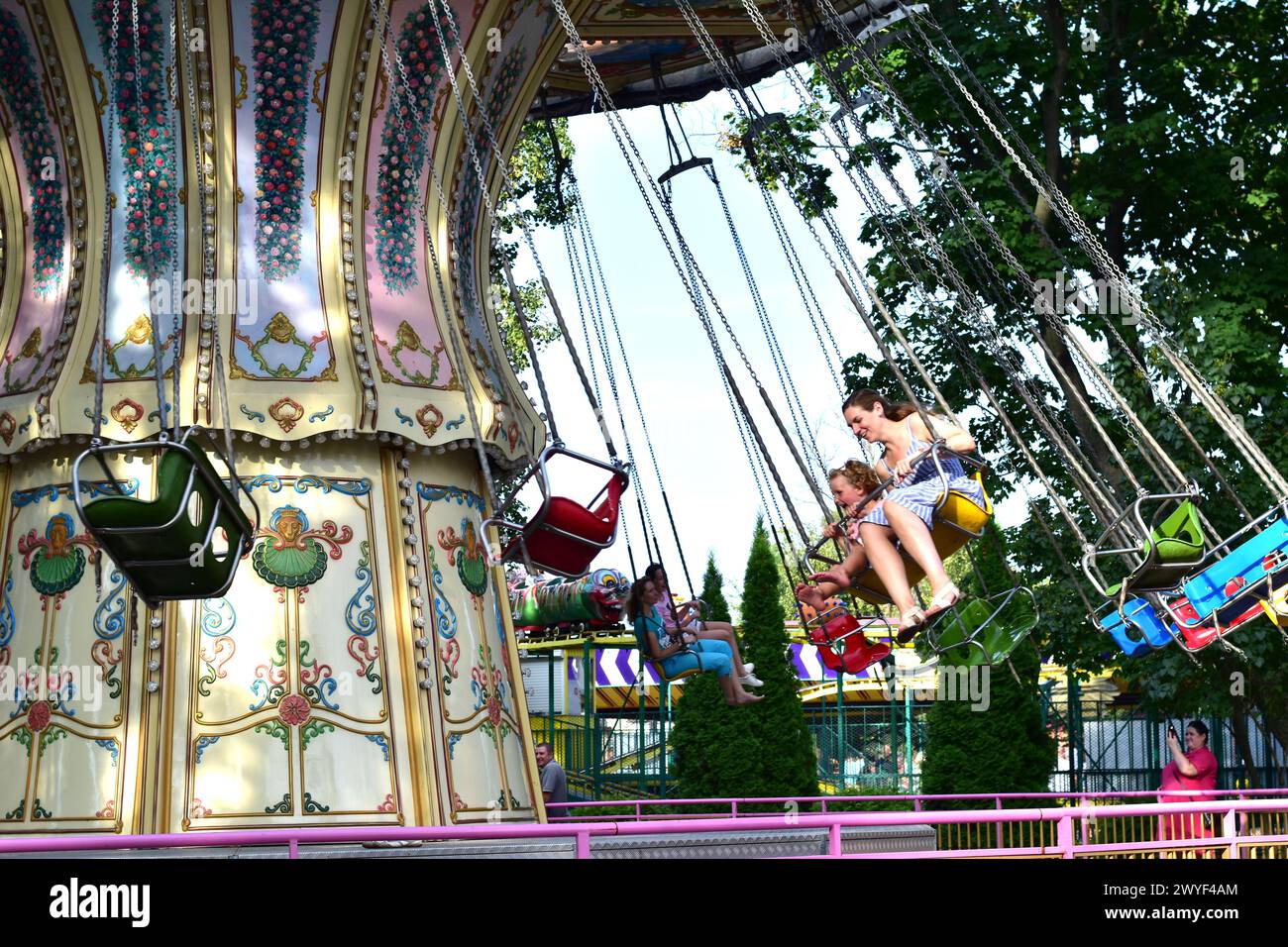 People Ride A Carousel In A City Park Stock Photo - Alamy