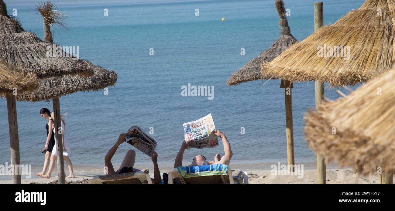 Palma, Spain. 06th Apr, 2024. A woman and a man read the newspaper on ...