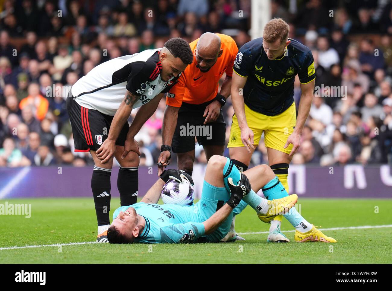 Newcastle United goalkeeper Martin Dubravka lies in pain after pulling up injured again during ...