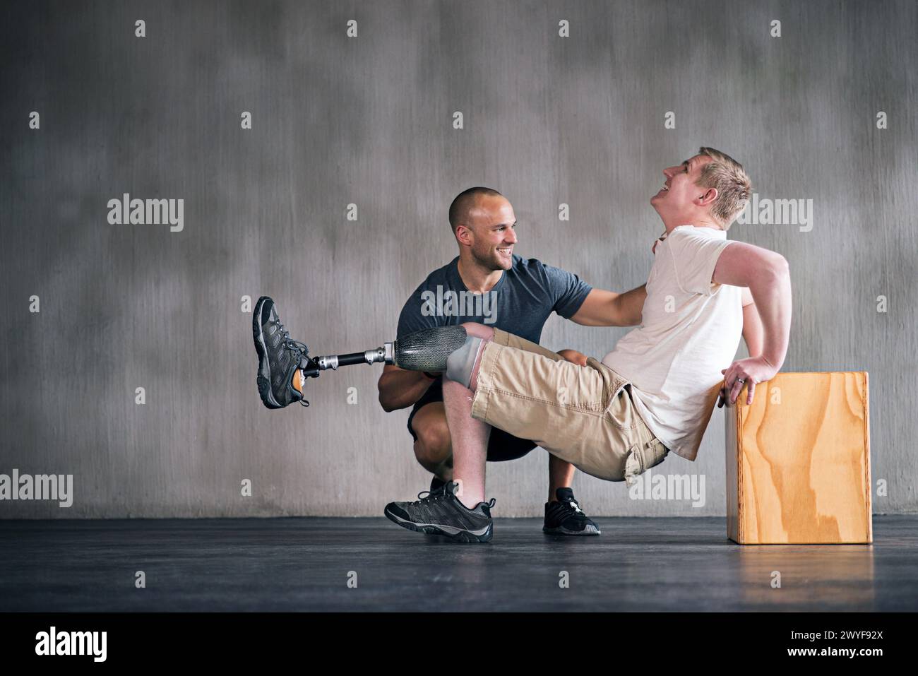 Physiotherapist, person with a disability and prosthetic leg and ...