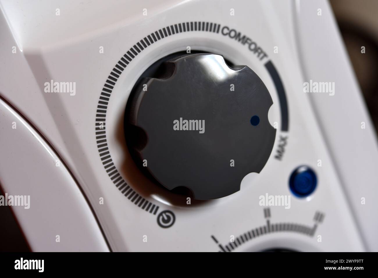 Round switches on a white radiator. The control panel Stock Photo - Alamy