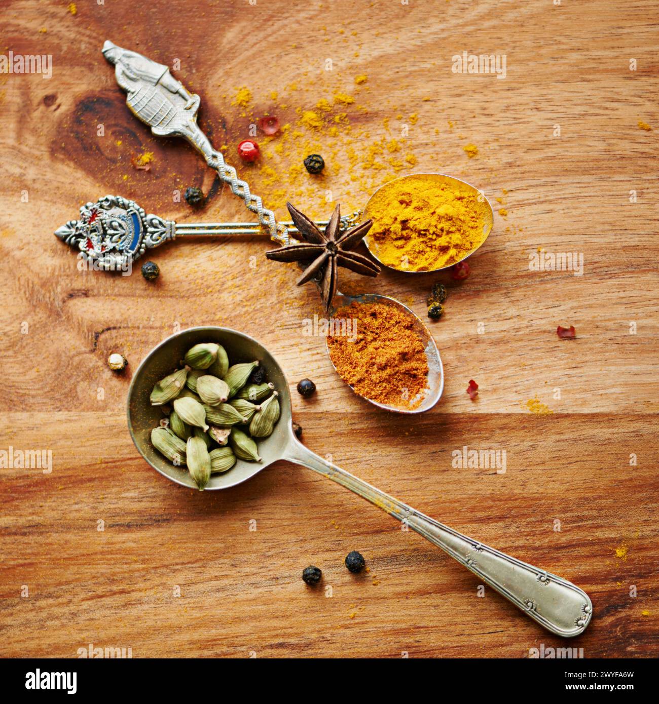 Spoons, spice and selection of color for seasoning on kitchen table ...