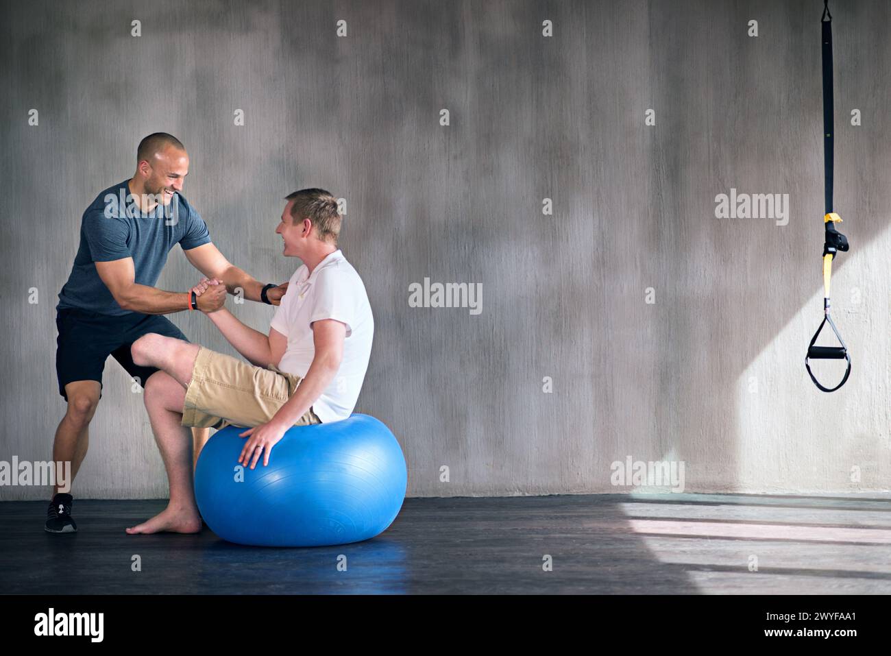 Amputee, exercise ball and rehabilitation with physiotherapist at gym ...