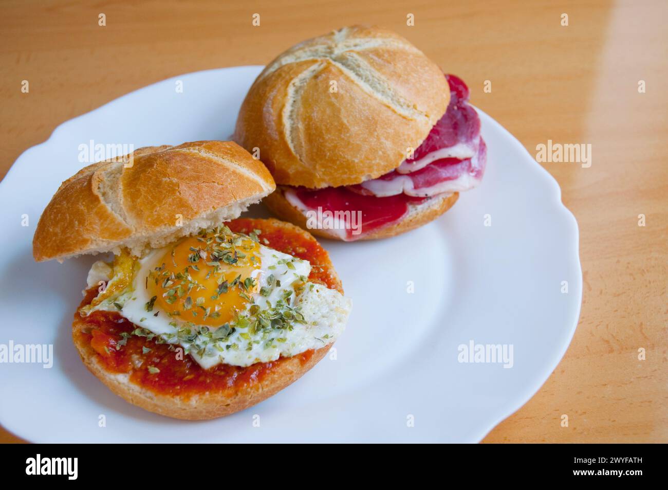 Spanish tapas: fried egg with tomato sauce and Iberian loin. Spain ...