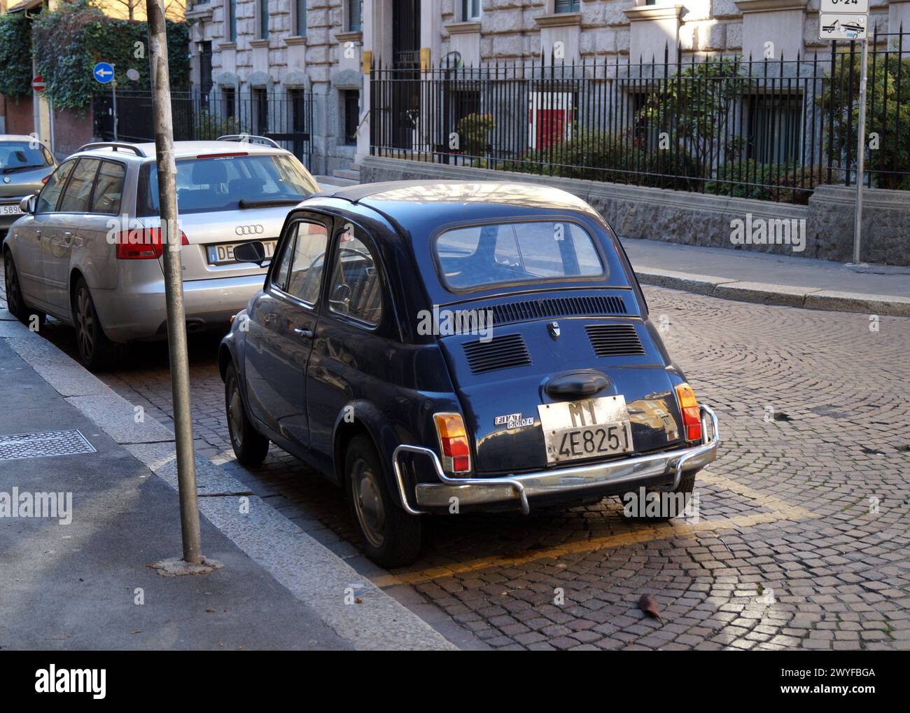 Late 1960s - early 1970s dark blue Fiat 500L parked by a boardwalk on a ...