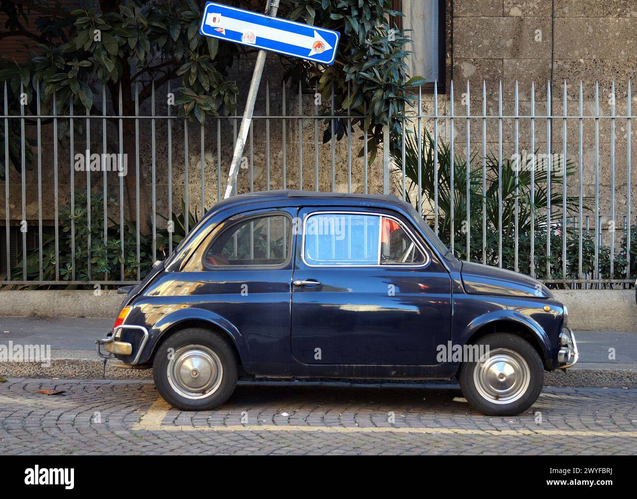Late 1960s - early 1970s dark blue Fiat 500L parked by a sidewalk on a ...