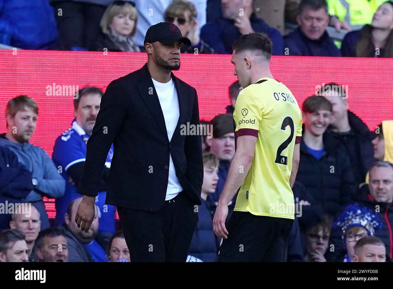 Burnley's Dara O'Shea (right) walks past manager Vincent Kompany after ...