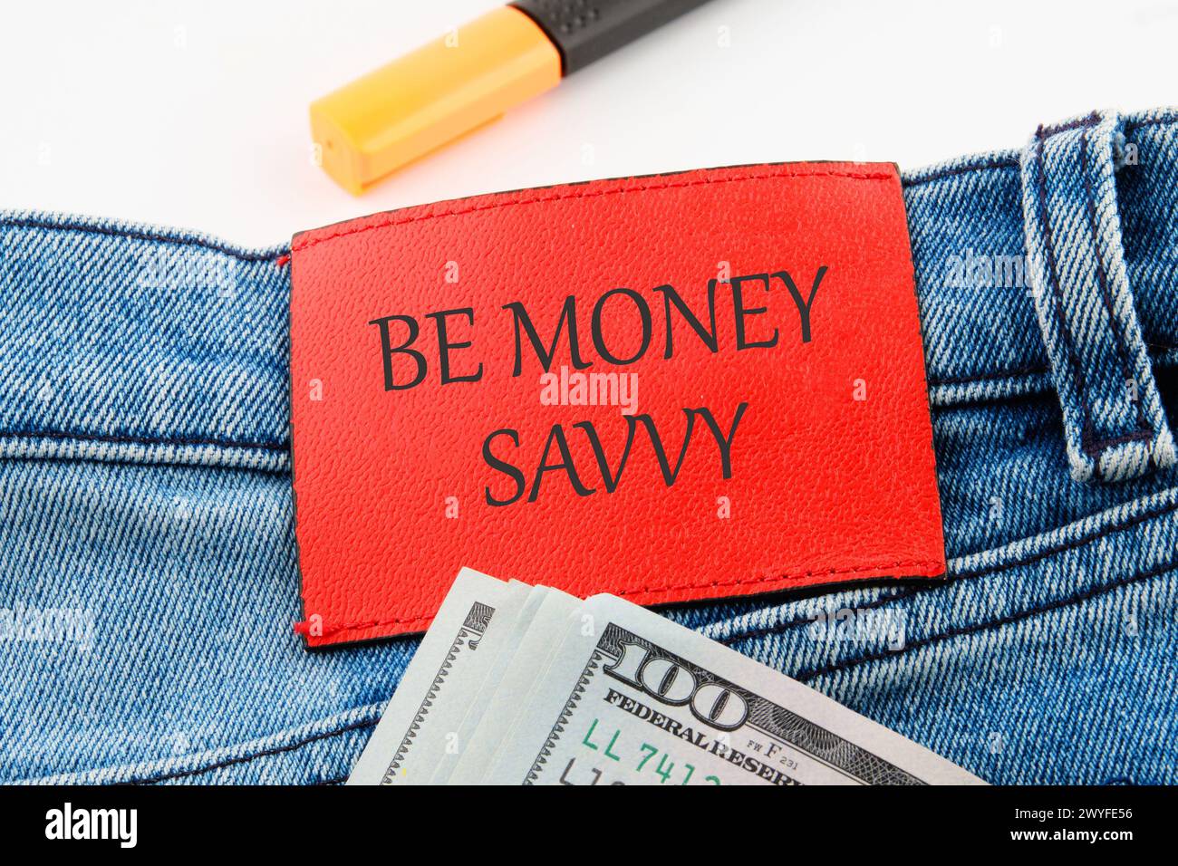 Savings concept,Text Be money savvy on the leather insert of jeans with ...