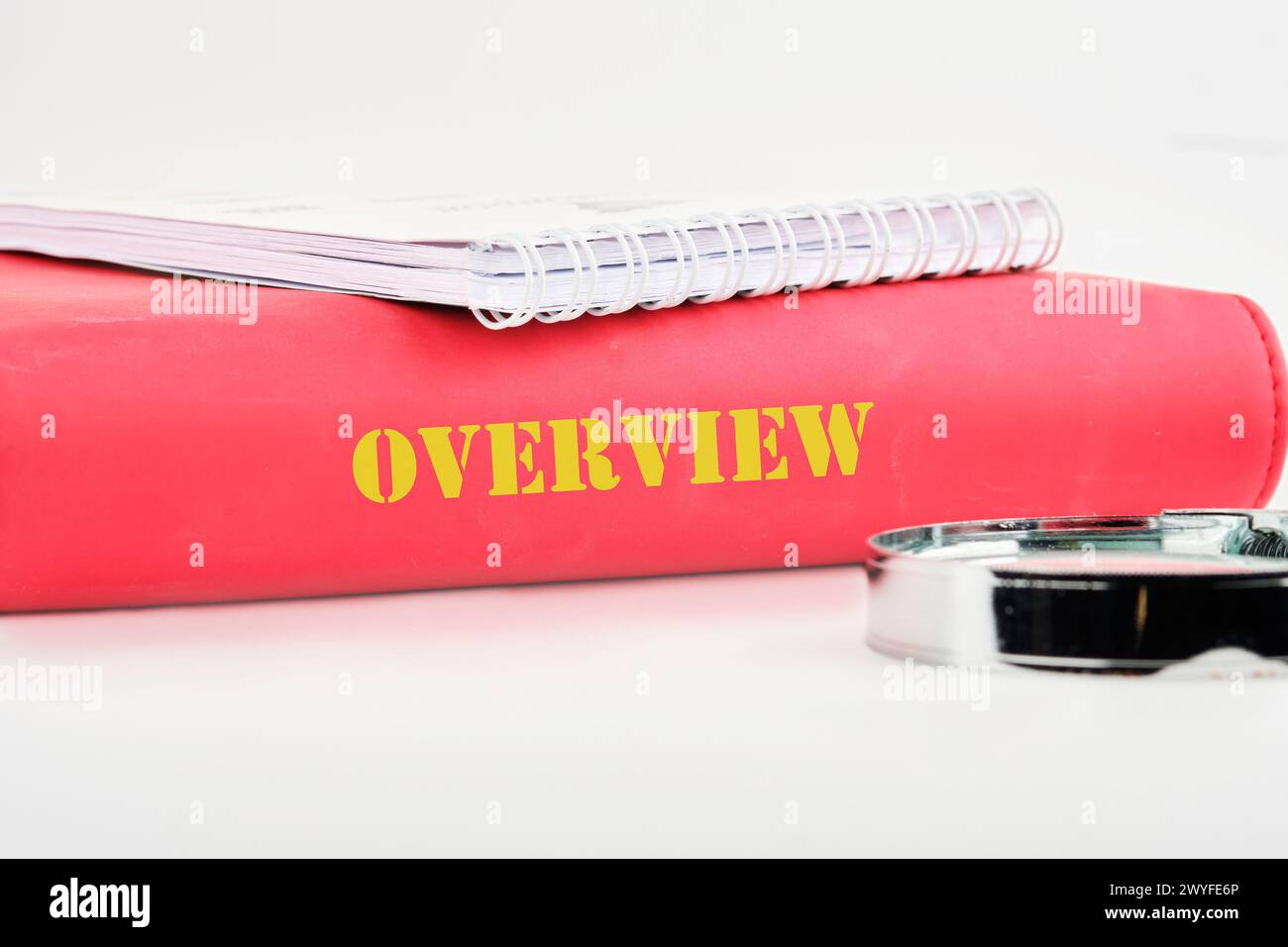 OVERVIEW written on the back of the book cover, a notebook on a white ...