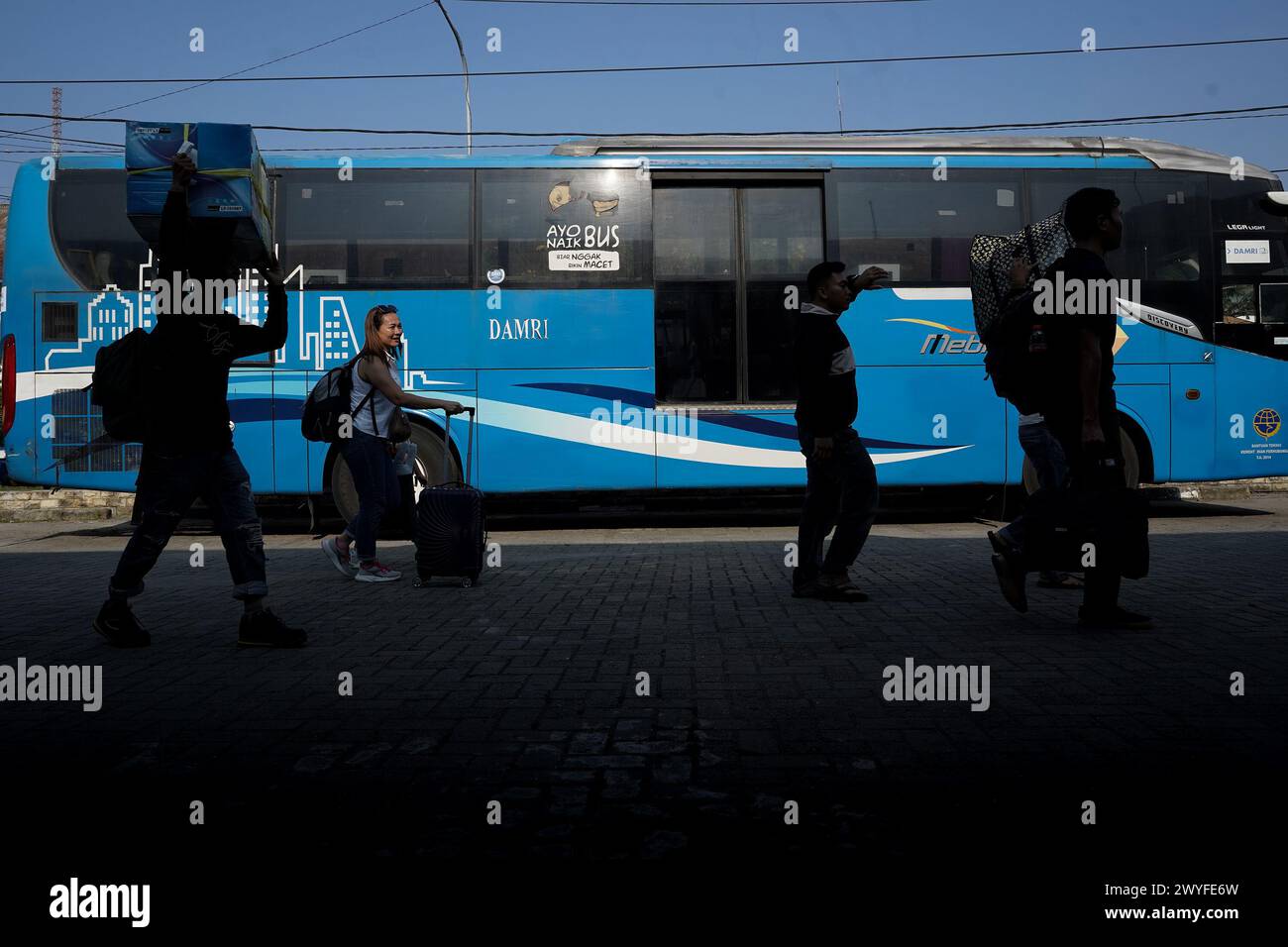 April 6, 2024, Medan, North Sumatra, Indonesia: The travelers walk past ...