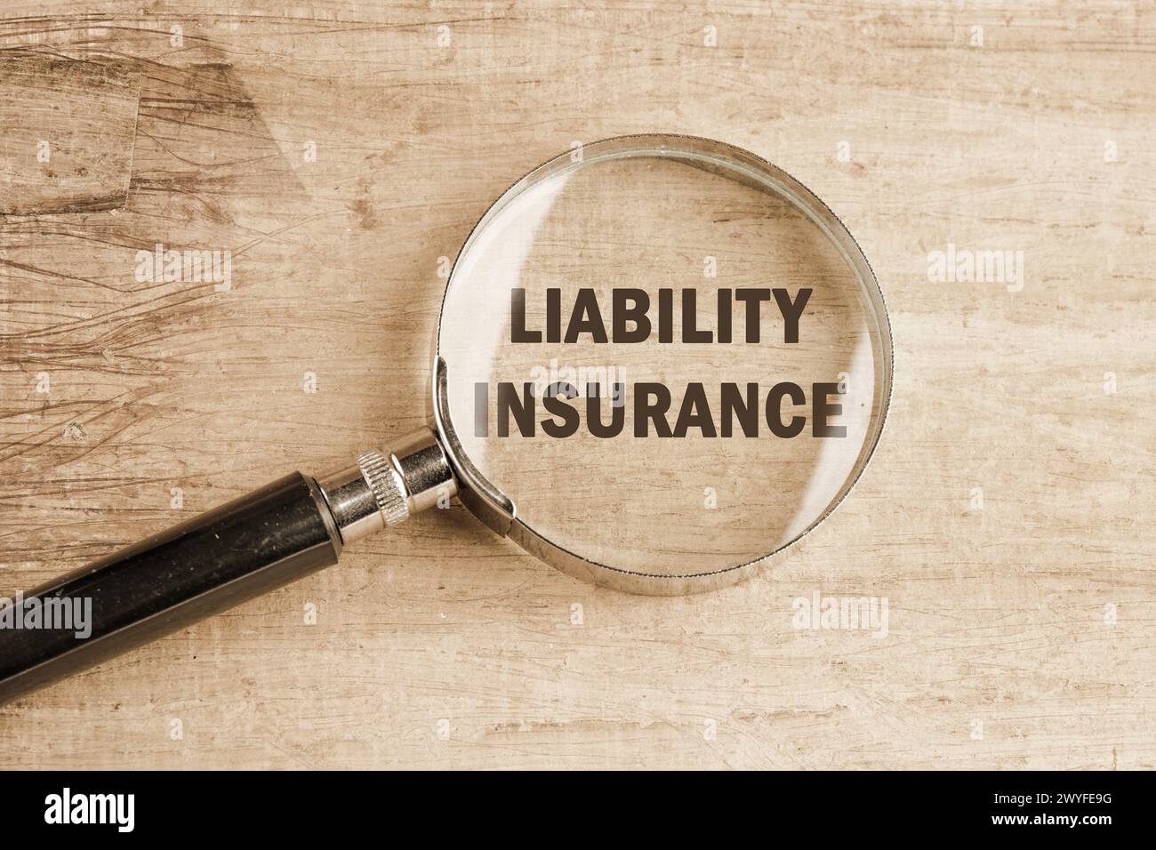 Text Liability Insurance visible through a magnifying glass on an old ...