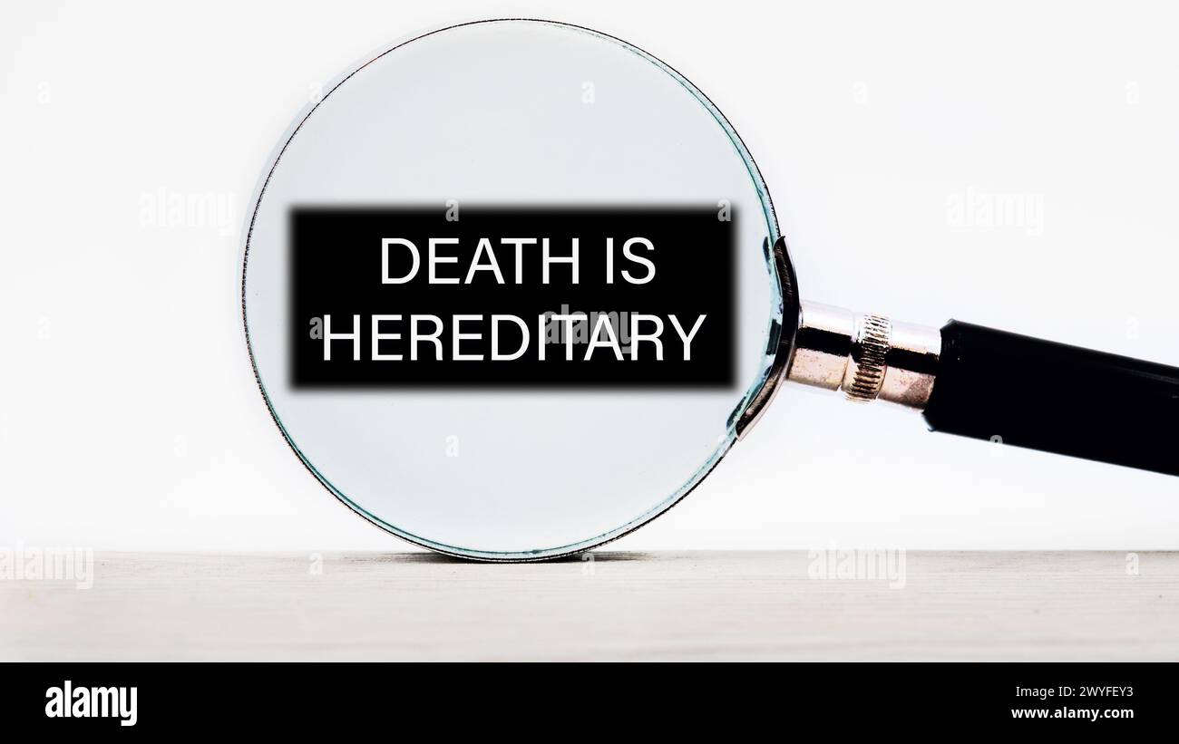 DEATH IS HEREDITARY text written through a magnifying glass Stock Photo ...