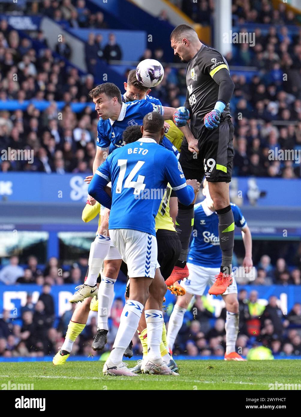 Burnley goalkeeper Arijanet Muric (right) attempts a headed shot ...