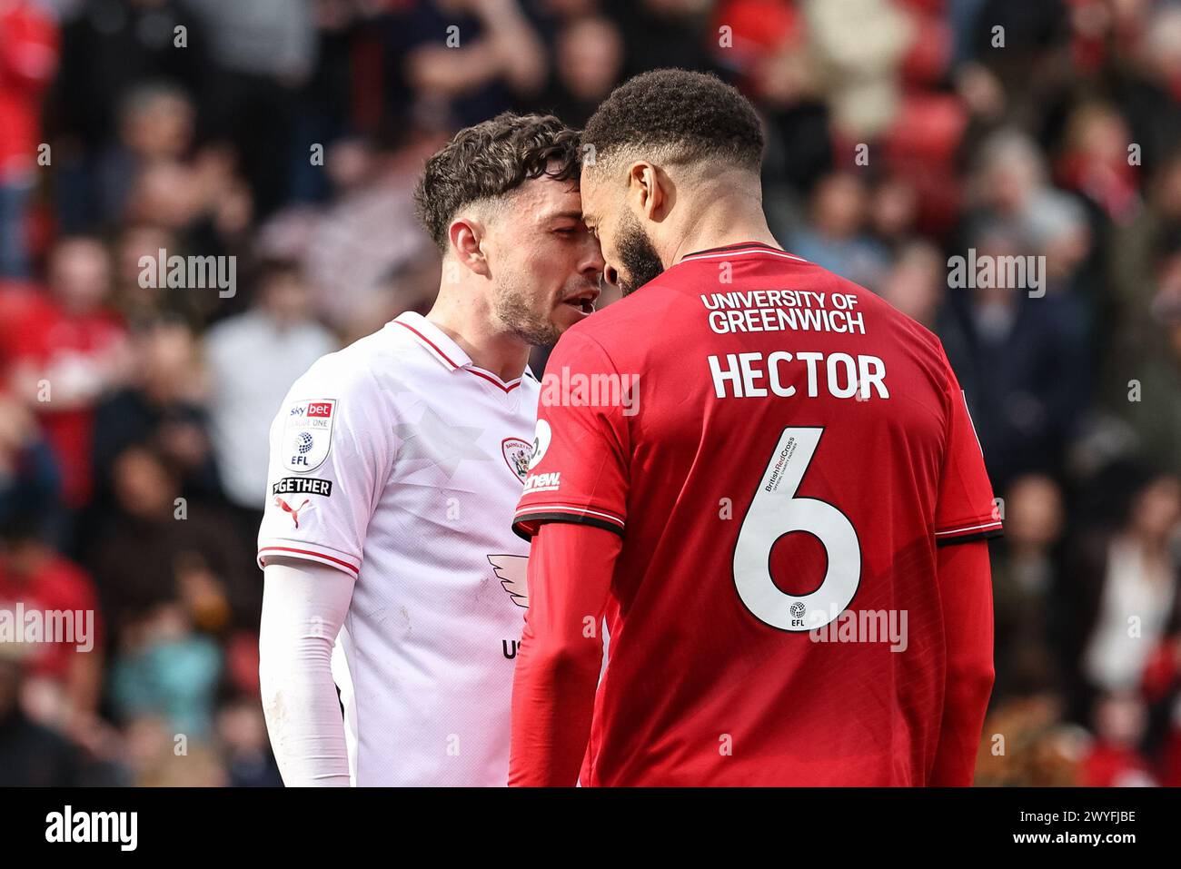 Corey O'Keeffe of Barnsley and Michael Hector of Charlton Athletic come ...