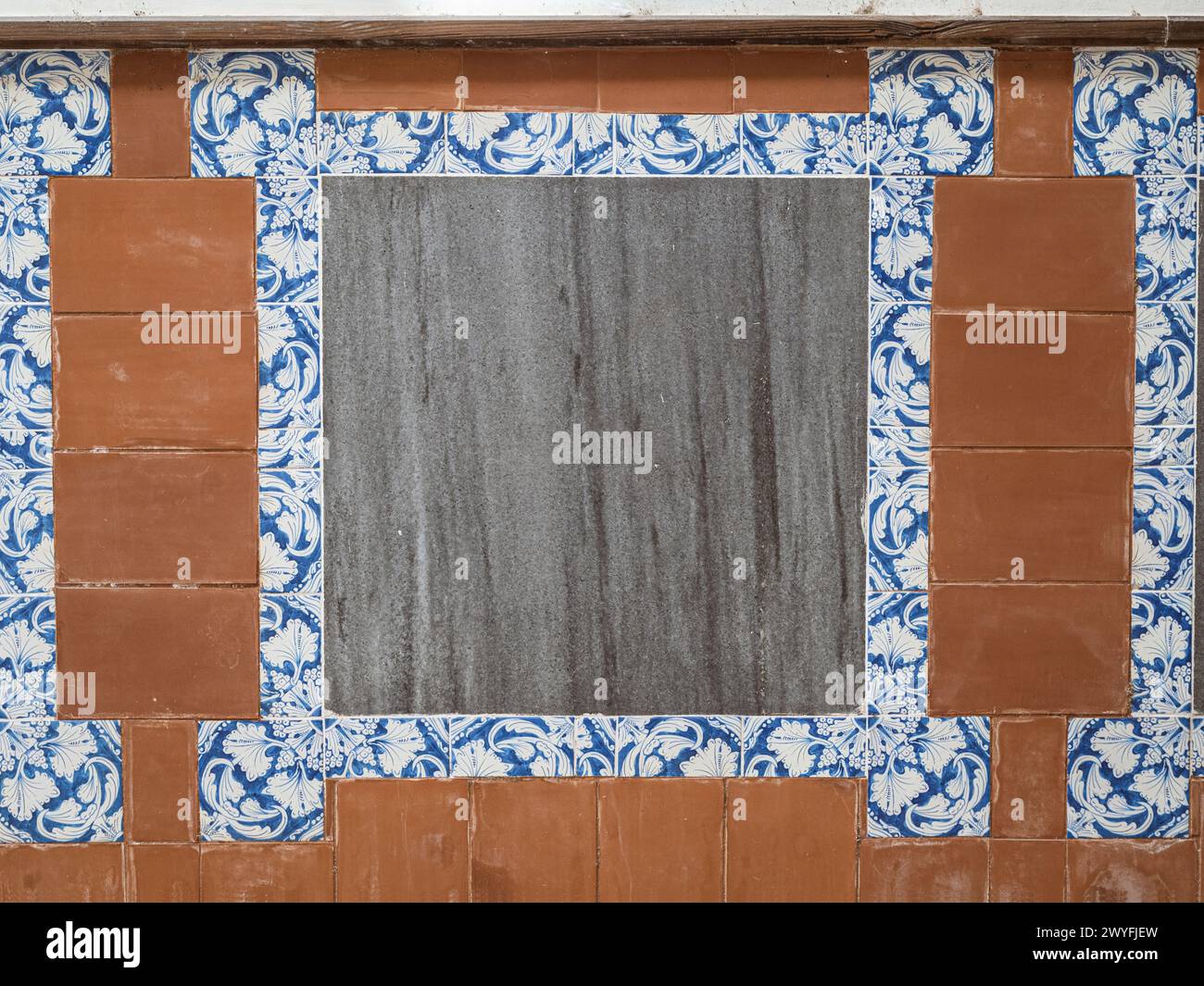 A frame made of traditional blue floral spanish tiles on a marble wall ...
