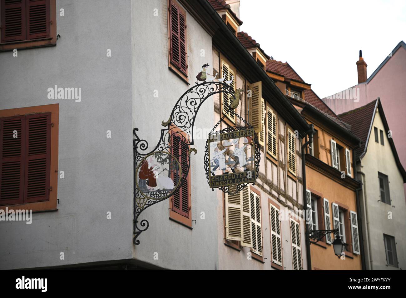 Antique handcrafted wrought iron sign of a local shop in Colmar, Alsace ...
