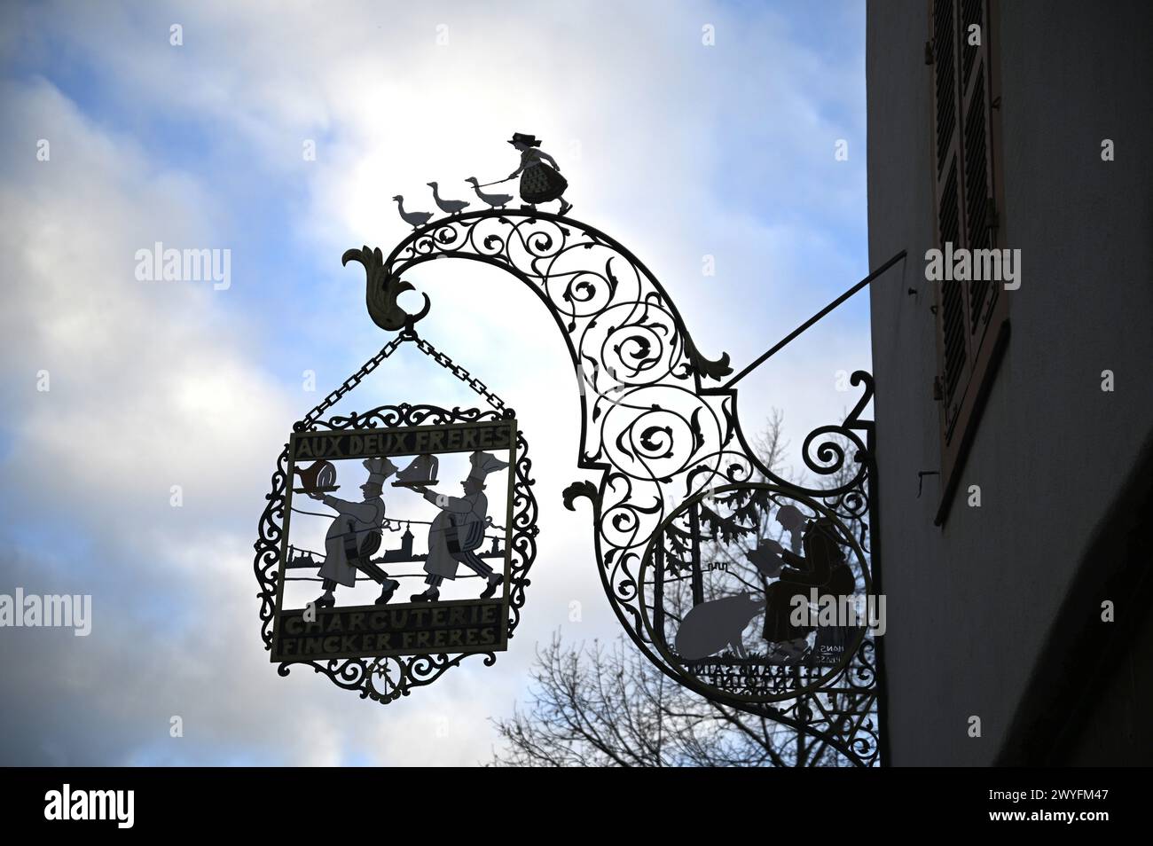 Antique handcrafted wrought iron sign of a local shop in Colmar, Alsace ...