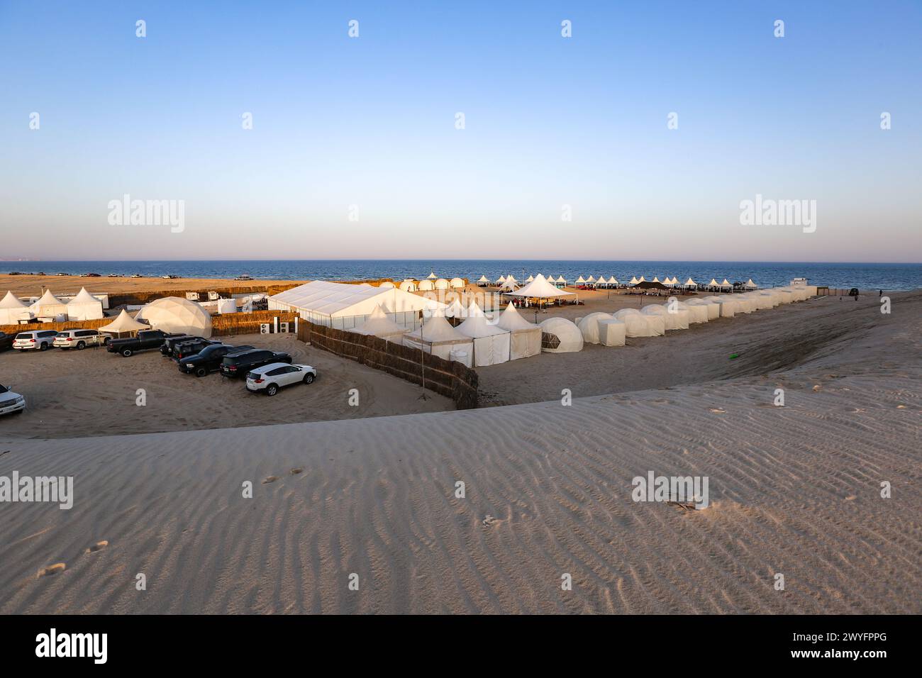 desert camp at Inland Sea in Persian Gulf at sunset sky. Middle East ...