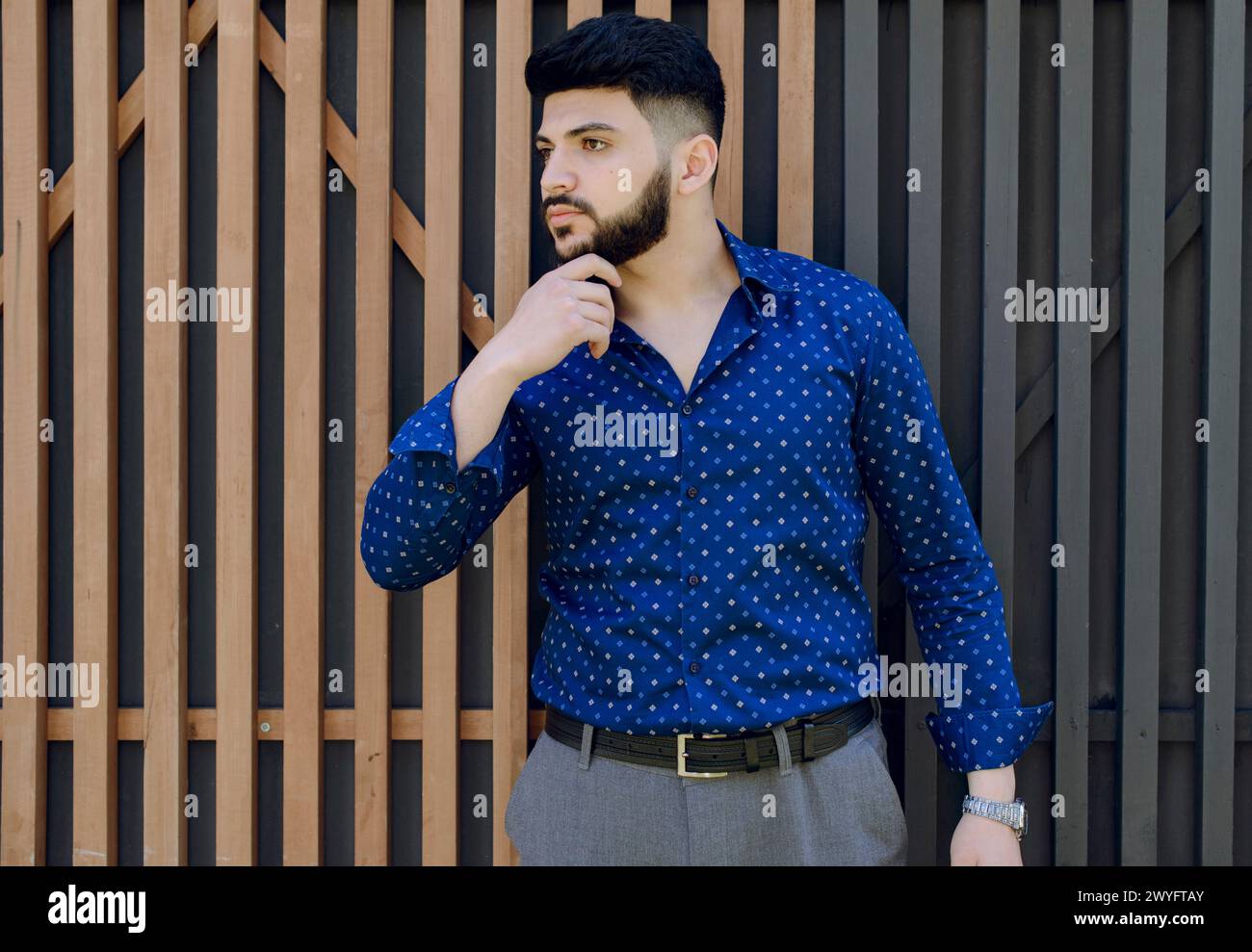 Handsome asian guy standing, touching chin Stock Photo - Alamy