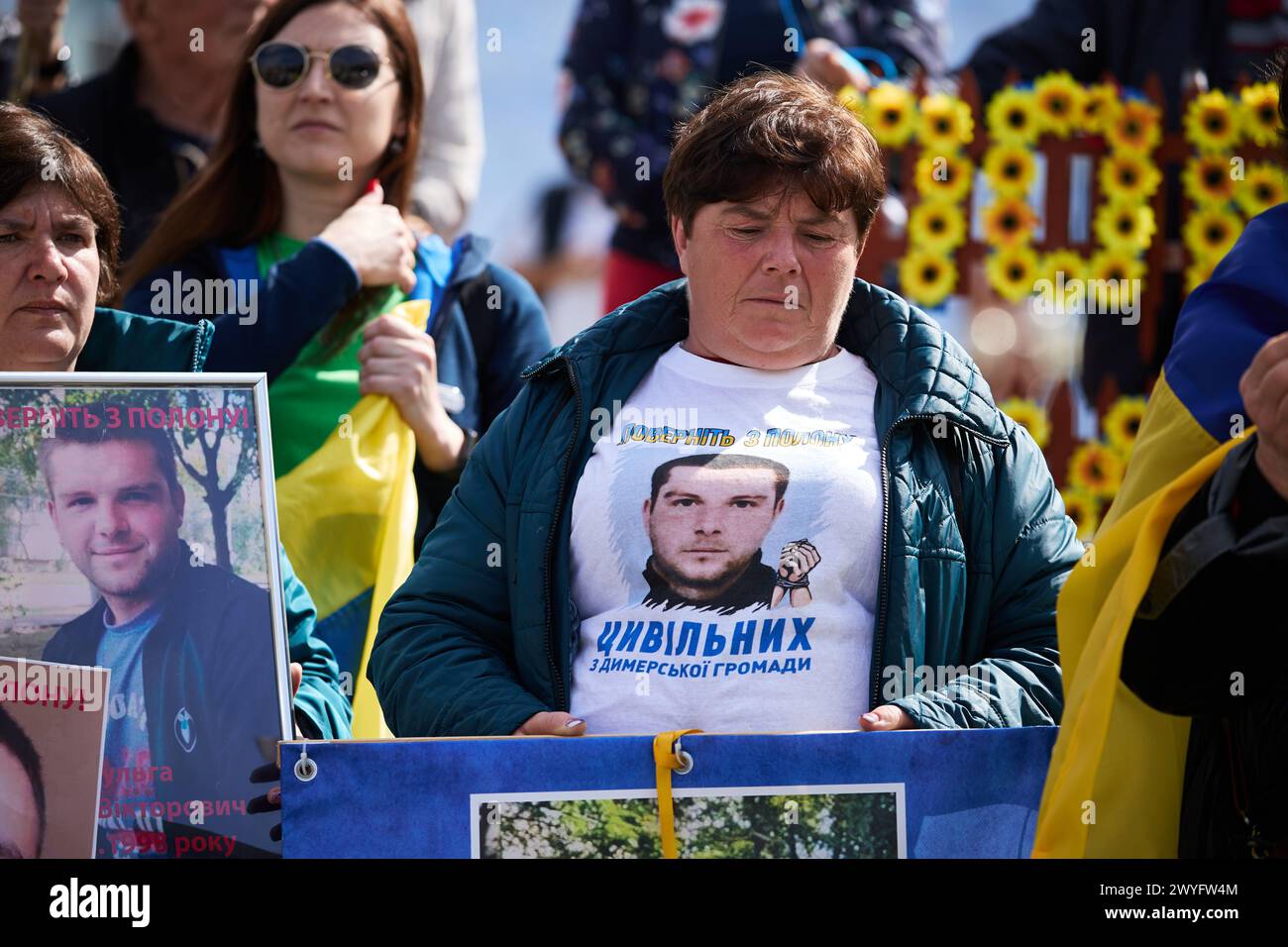 Sad Ukrainian woman wearing a shirt with a portrait of her son ...