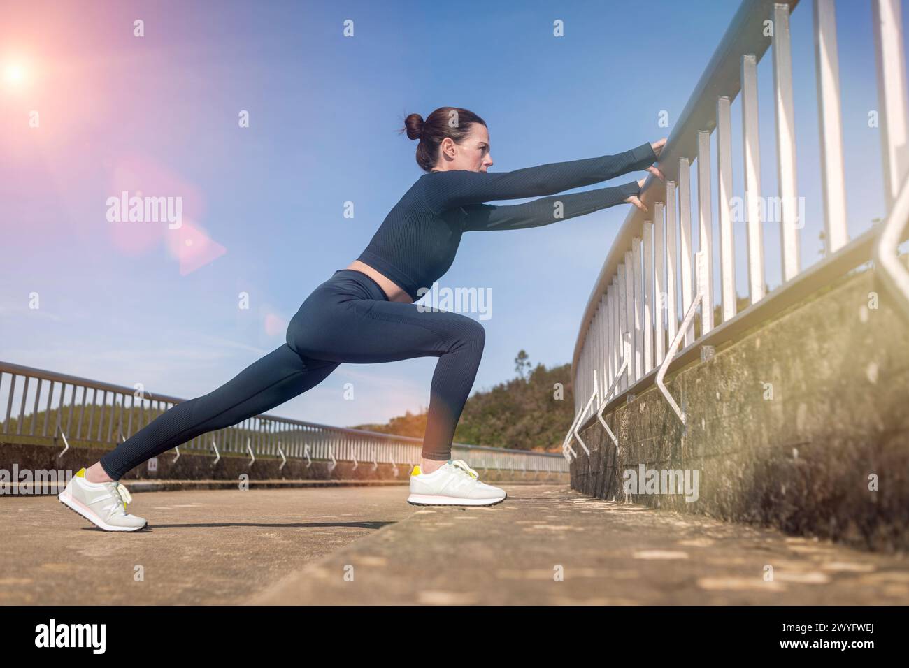 female runner doing warm up leg stretching exercises outside Stock ...
