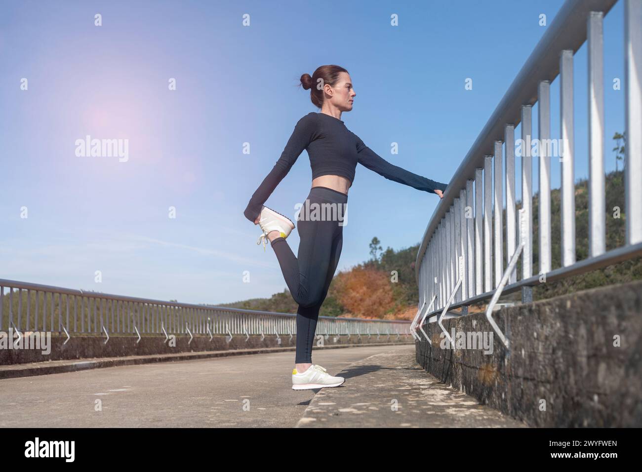 female runner doing warm up leg stretching exercises outside Stock ...