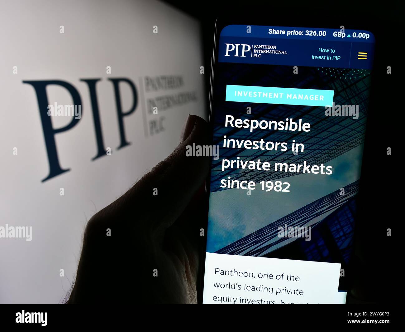 Person holding cellphone with webpage of British company Pantheon International plc (PIP) in ...