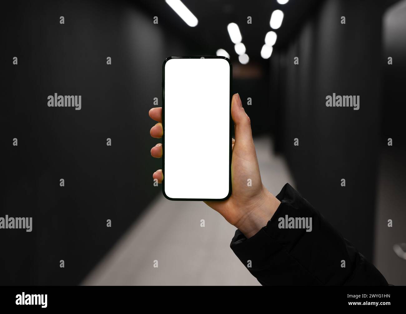 Hand holding smartphone mockup, blank mobile phone screen, long dark ...