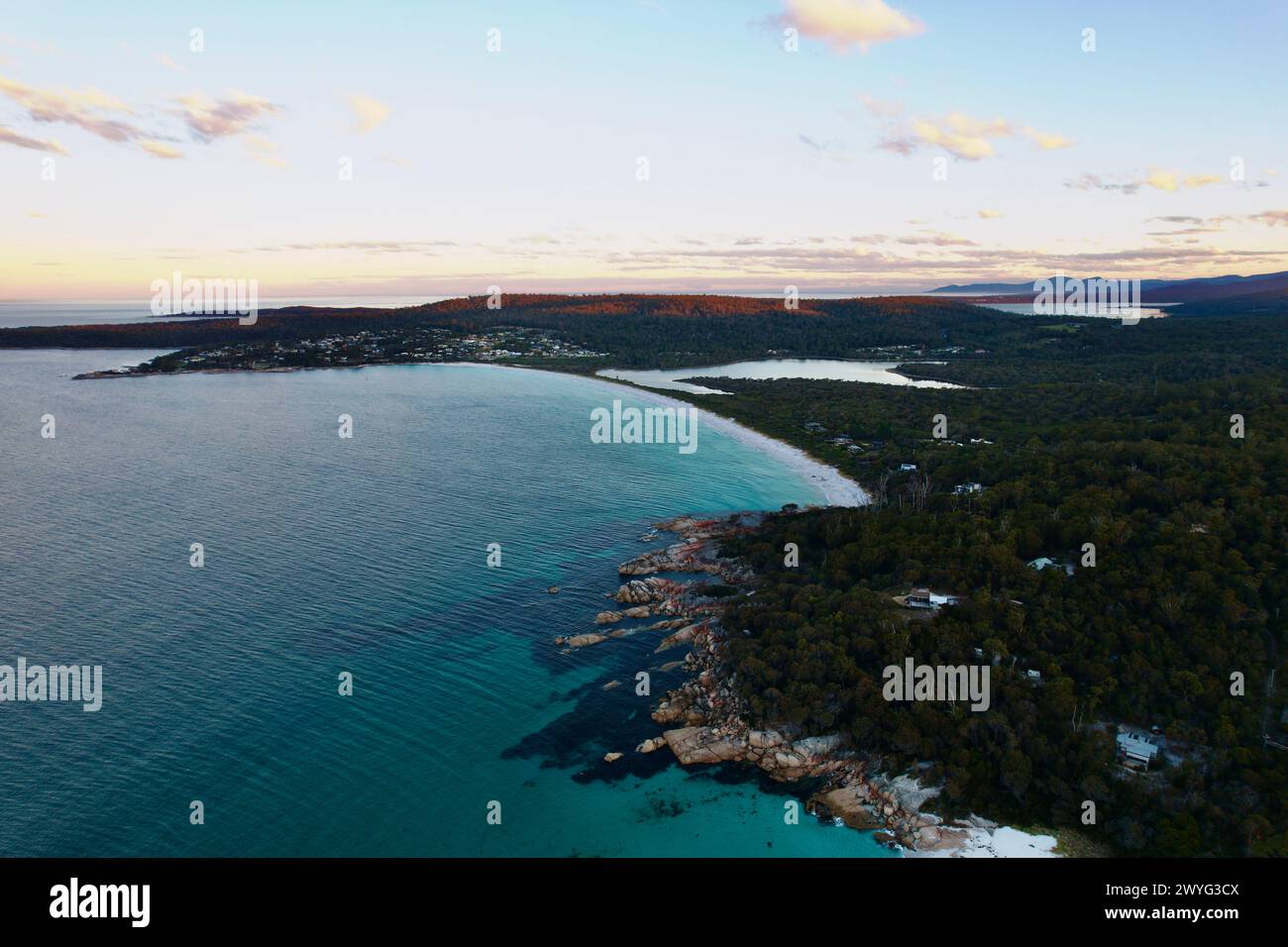 An Aerial White sand beach of Swimcart beach at sunset with Binalong ...