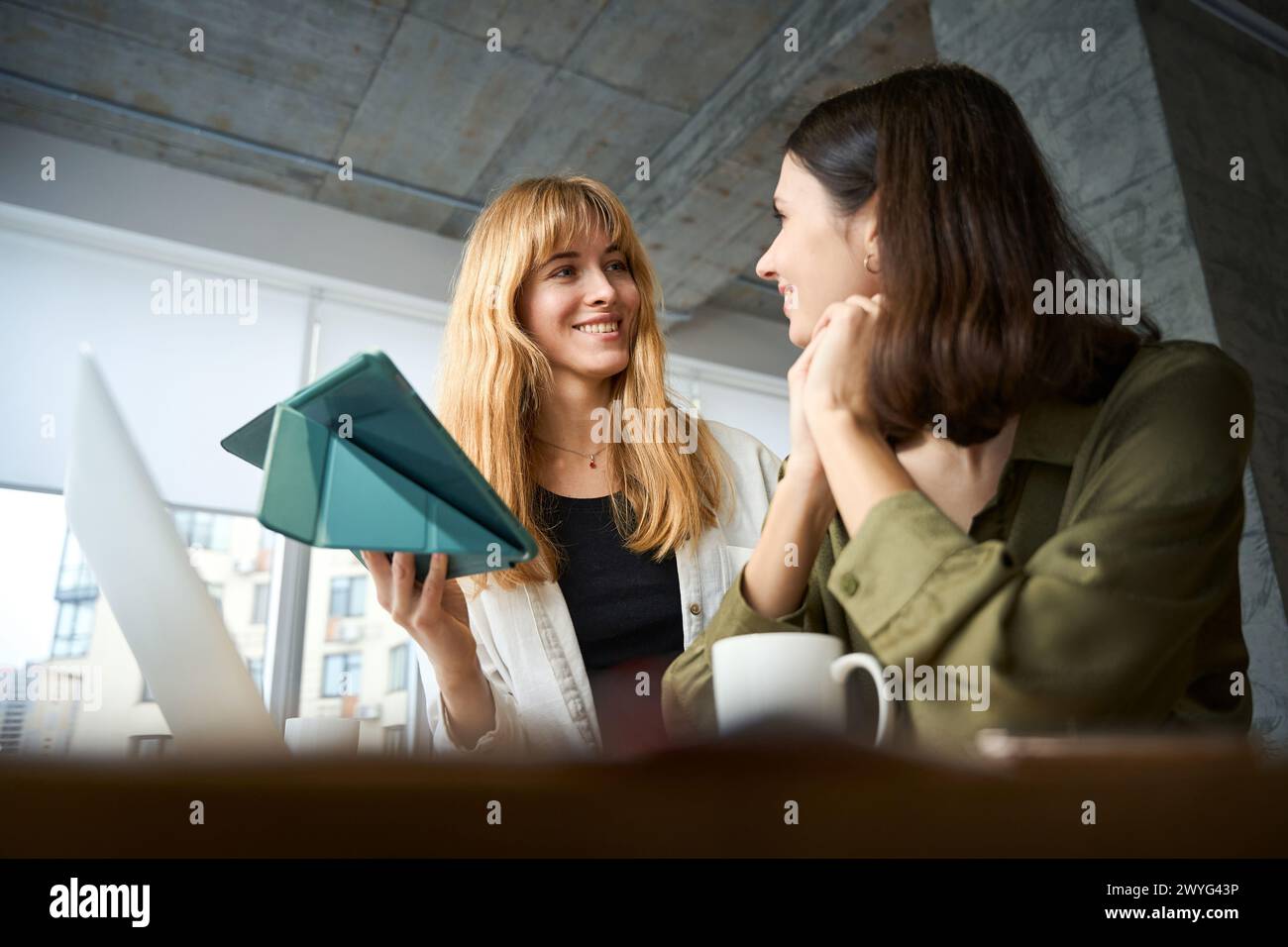 Fashion professionals in coworking environment sharing ideas of ...
