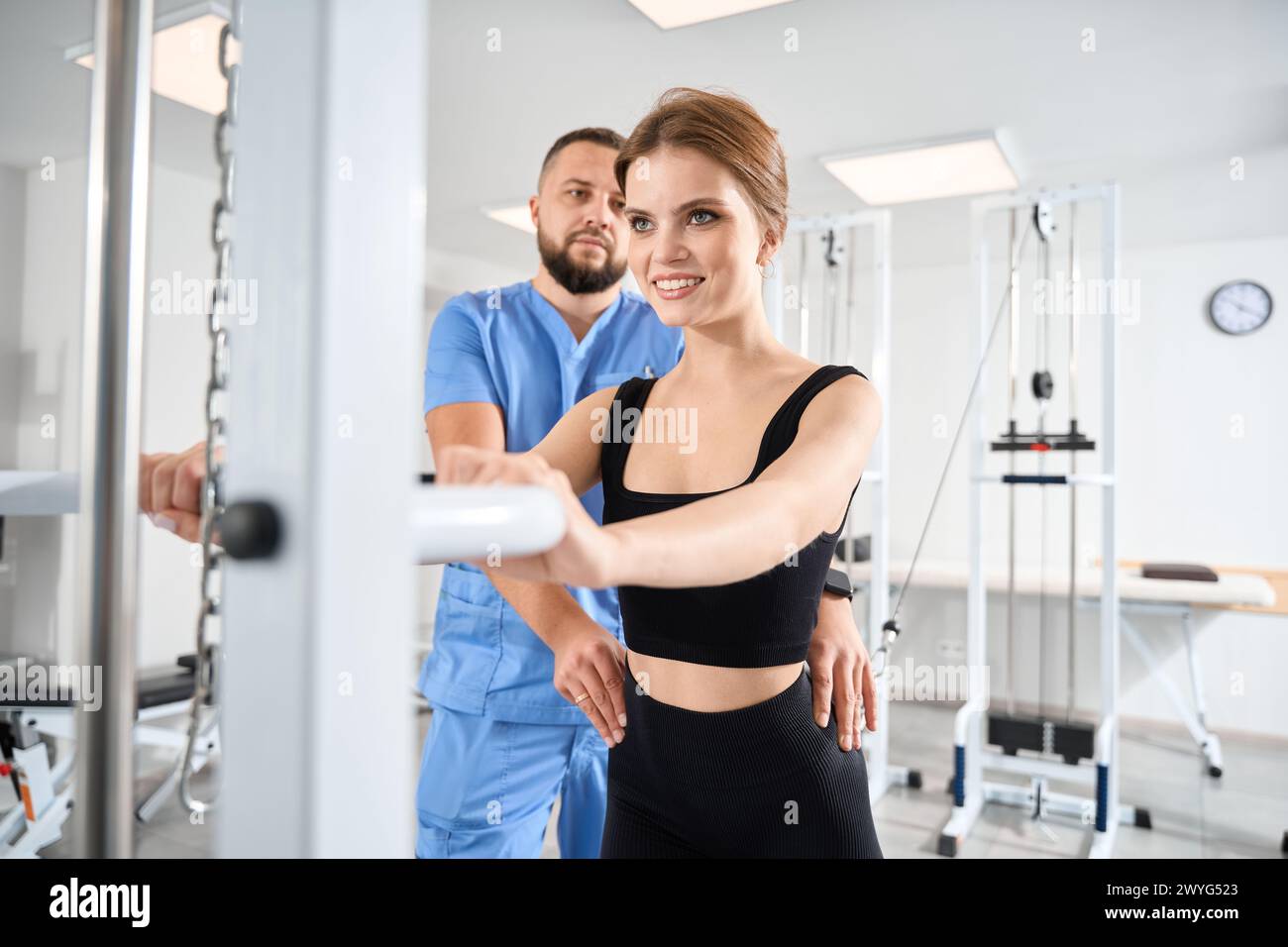 Patient strengthens her back muscles under the supervision of ...