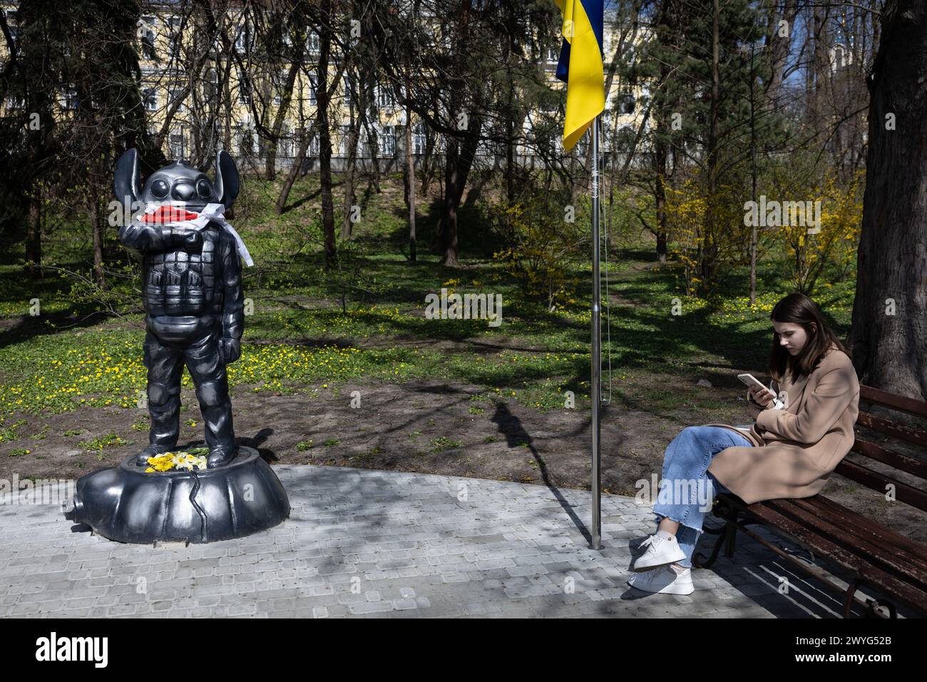 A girl spends time in the park next to the monument depicting the ...