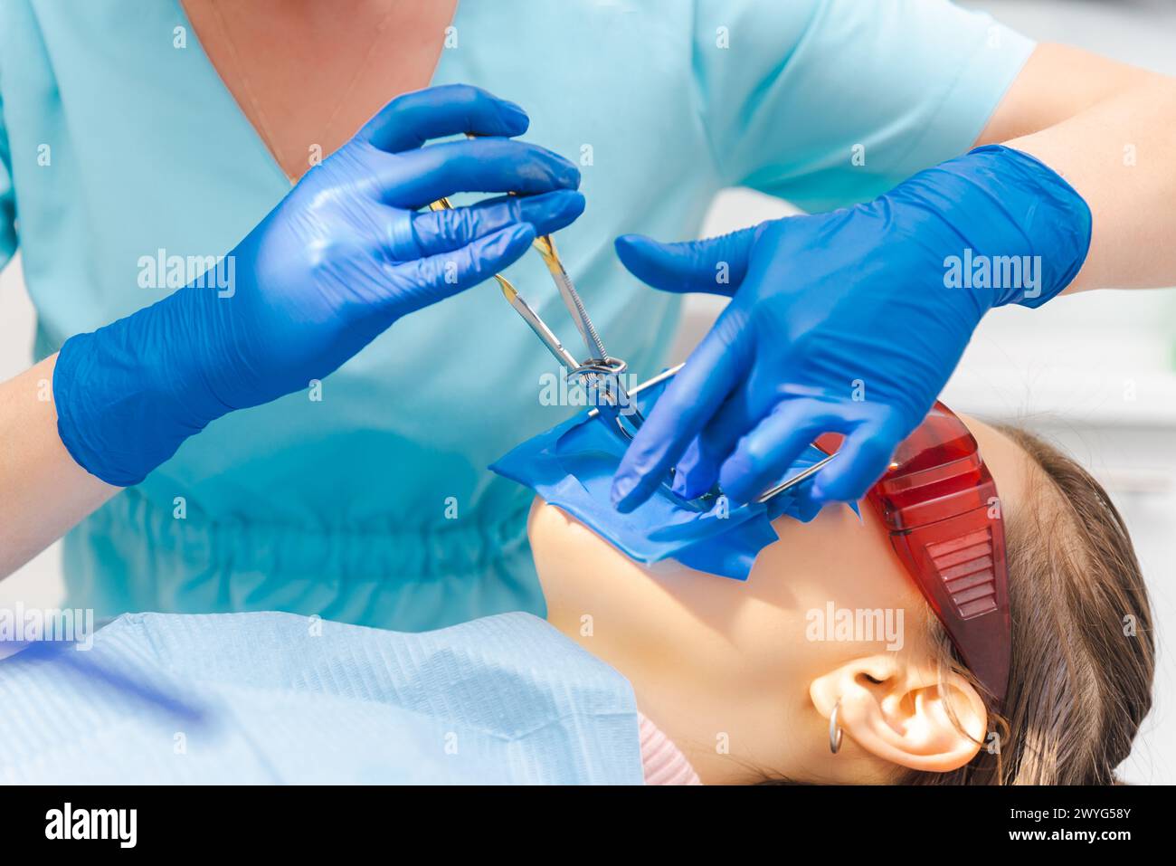 Dentist is working and making the treatments on a patient wearing ...