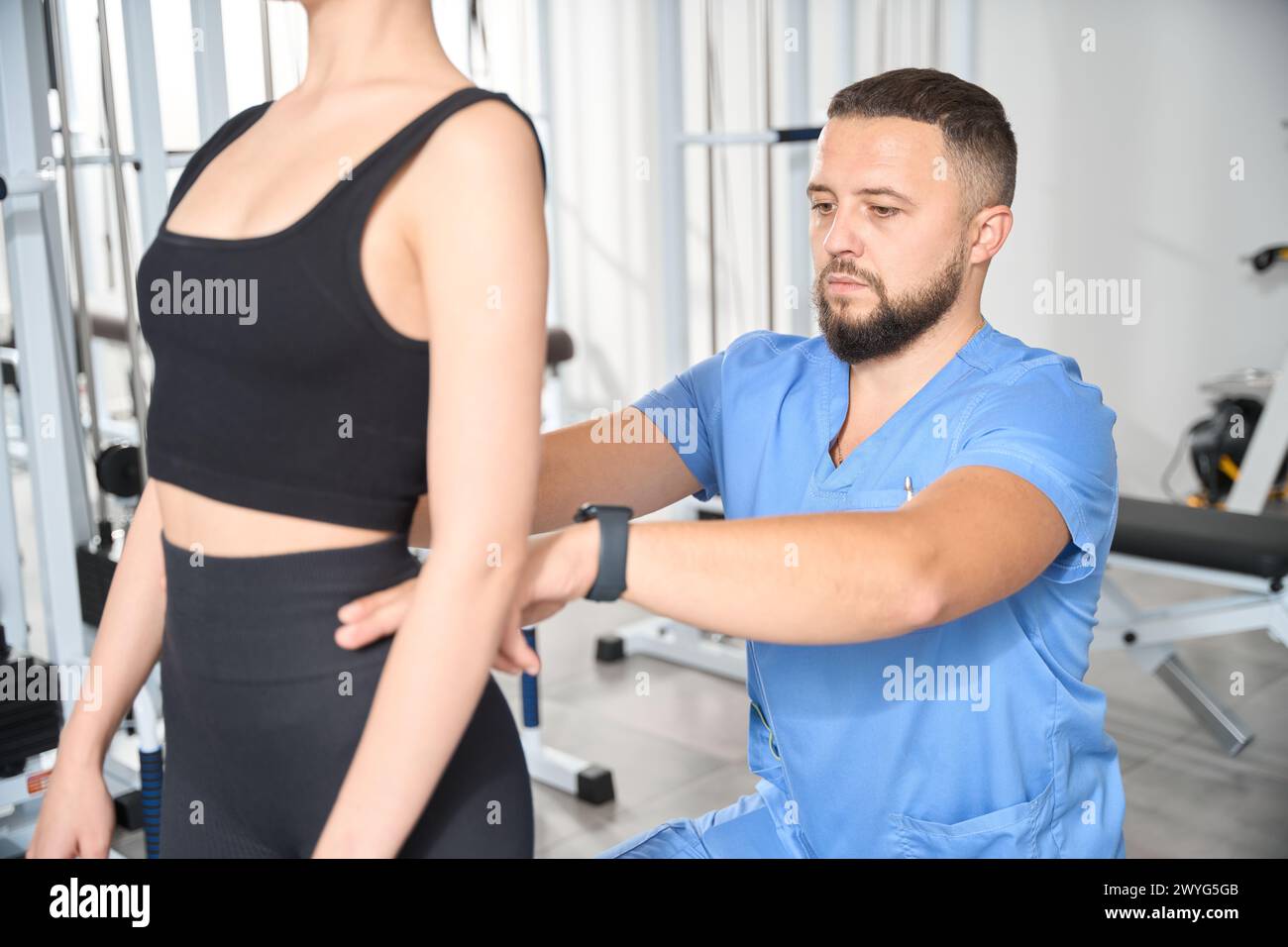 Chiropractor forms correct posture for a young patient Stock Photo - Alamy