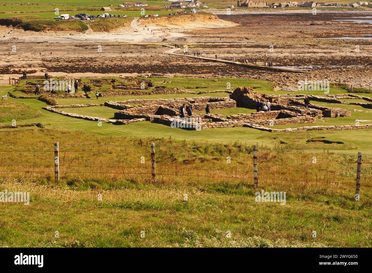 Visitors visiting the Norse settlement on the Brough of Birsay, Orkney ...